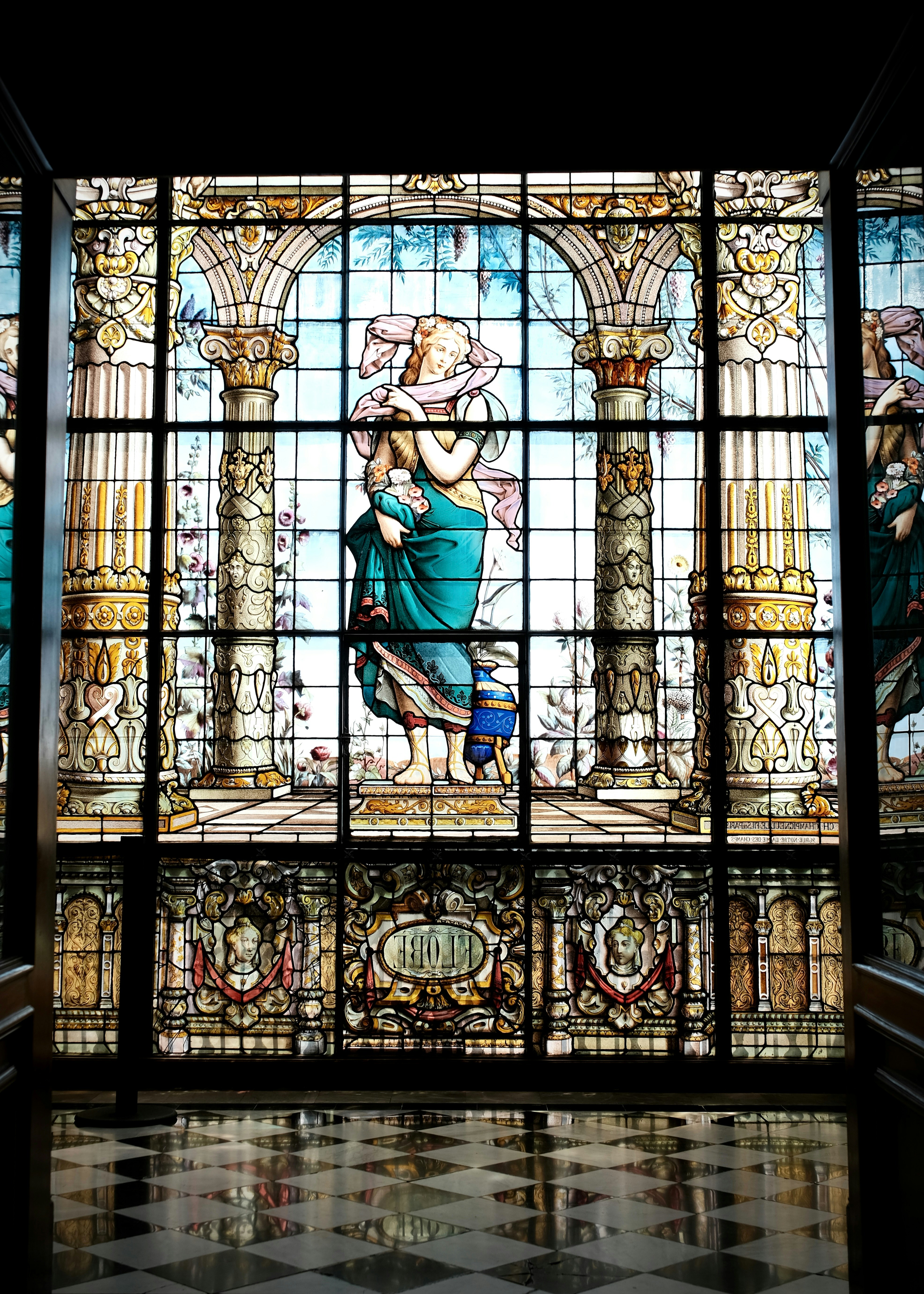 Gilded Archways Framing a Central Madonna in Stained Glass