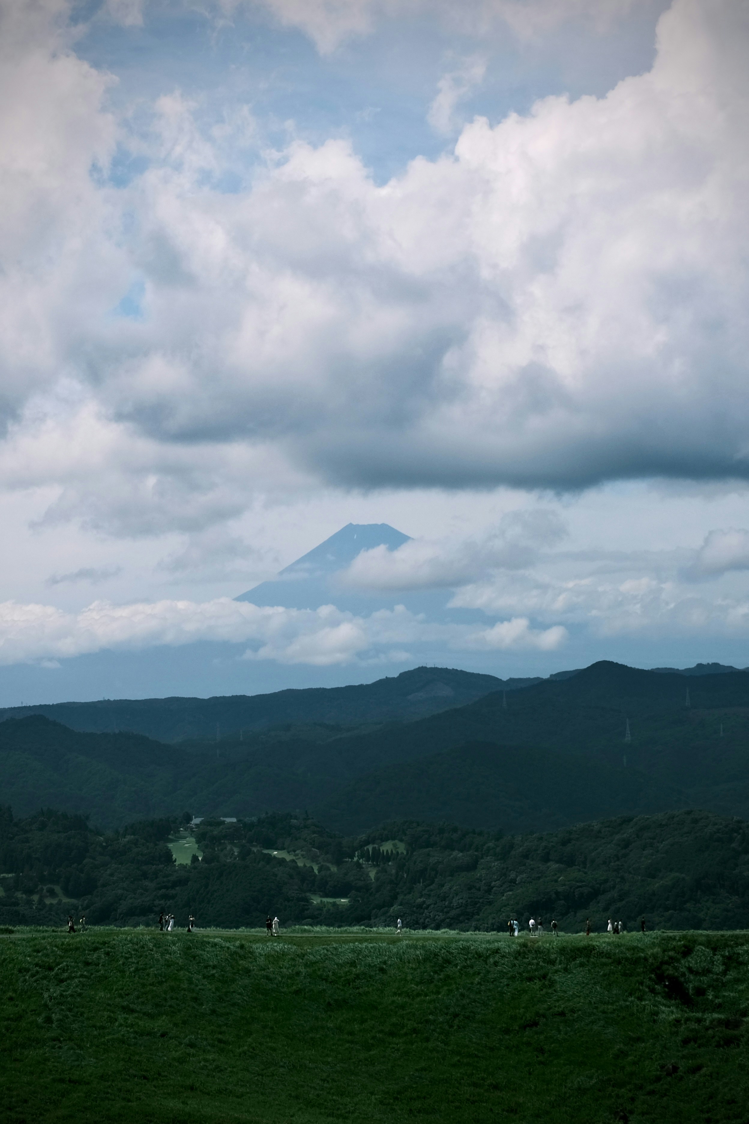 Veiled Peak Above Rolling Green Valleys