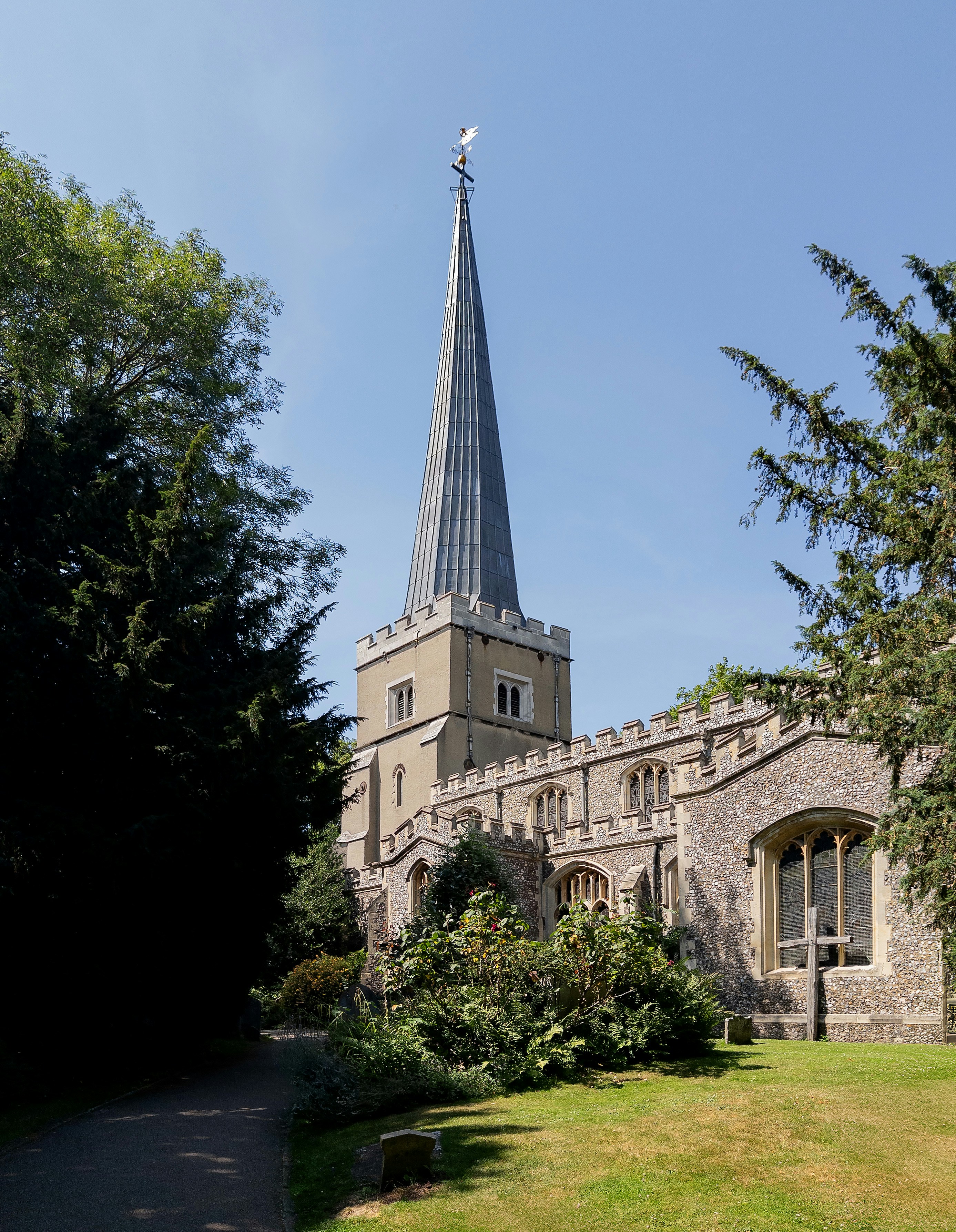 Spire and Cloister: A Sunlit Anglican Church Amid Greenery