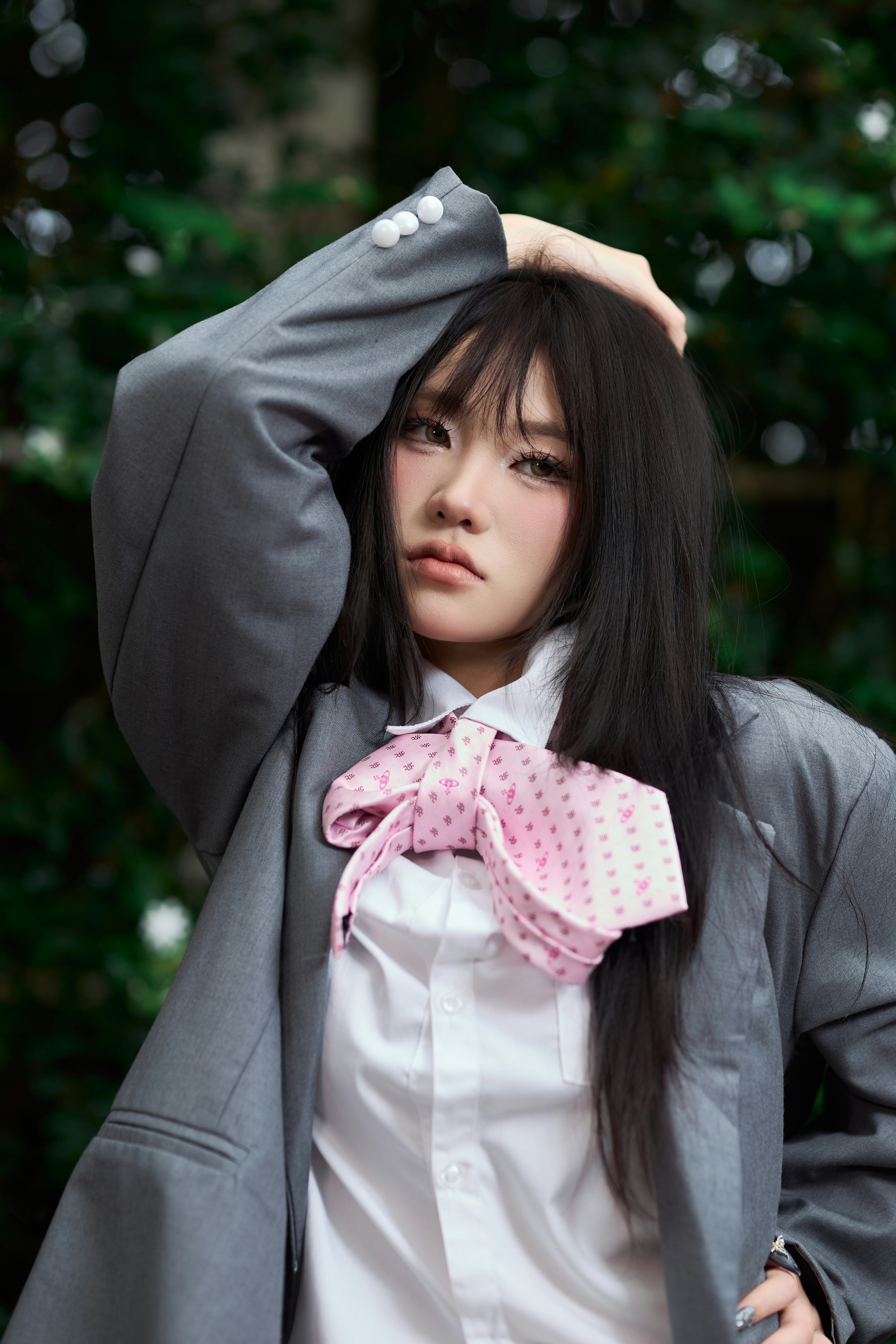 Soft Portrait in a Grey Suit: Pink Bow and Dreamy Gaze