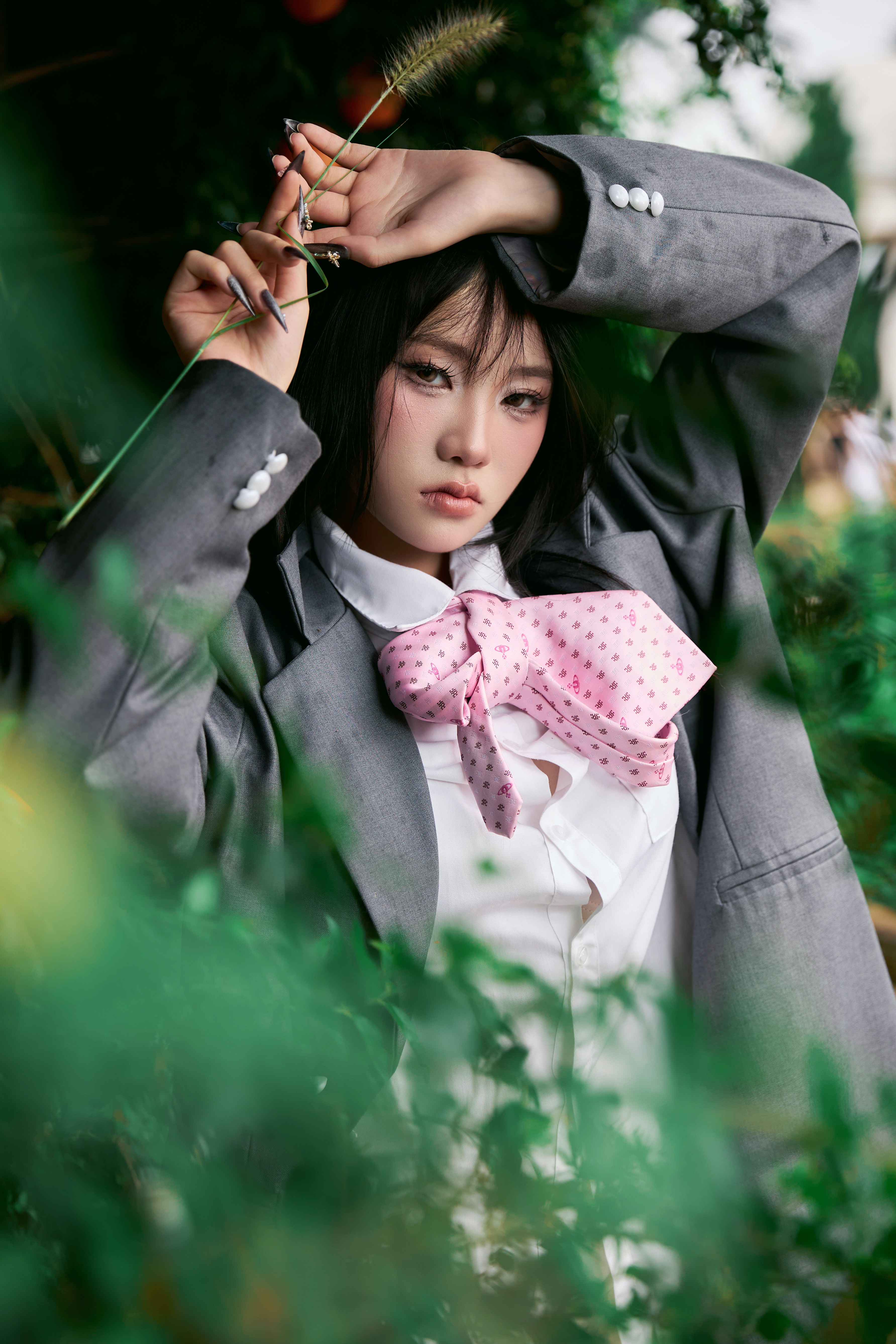 Grey blazer, pink bow, and a hidden garden gaze