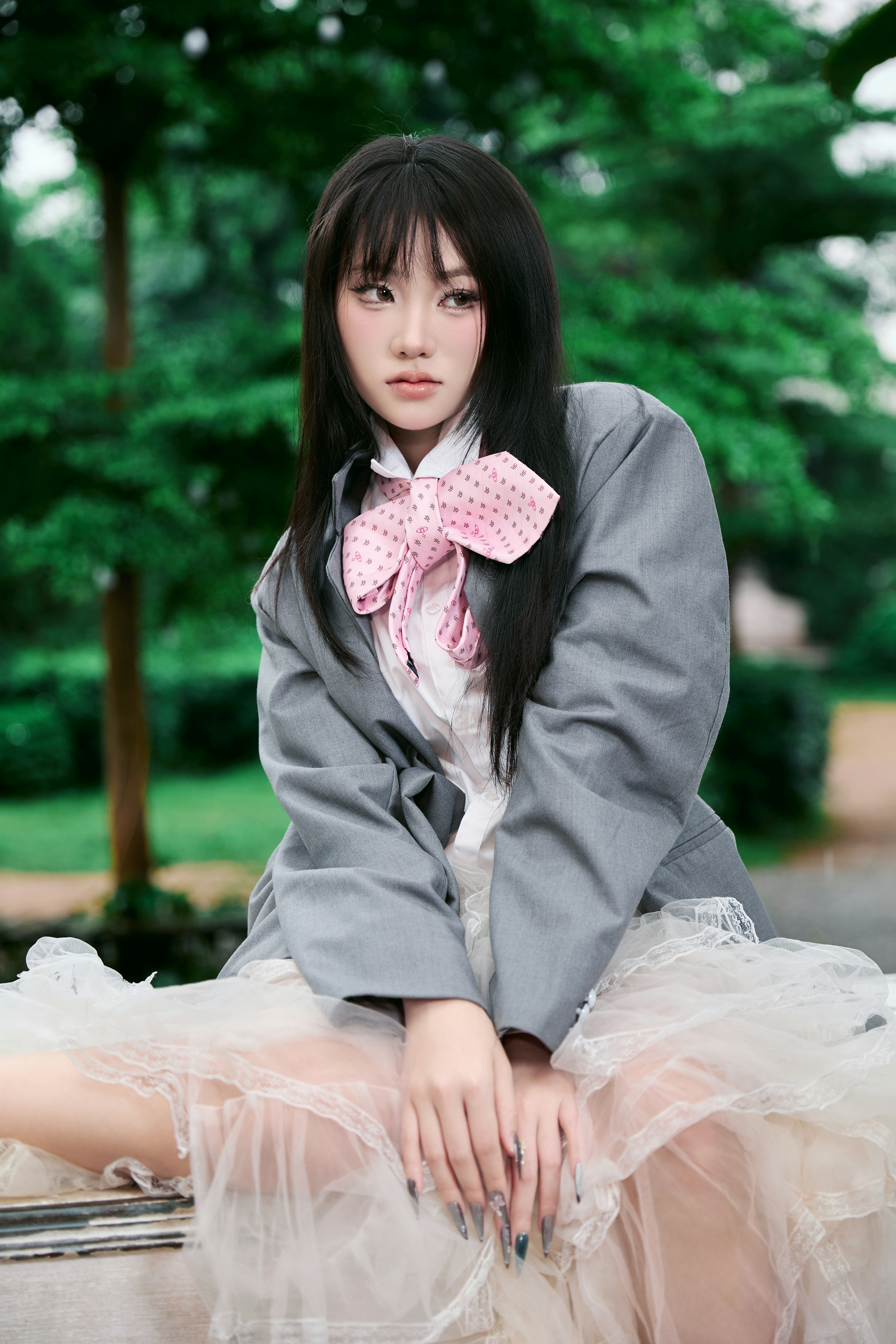 Pensive portrait on a garden bench with a pale pink bow