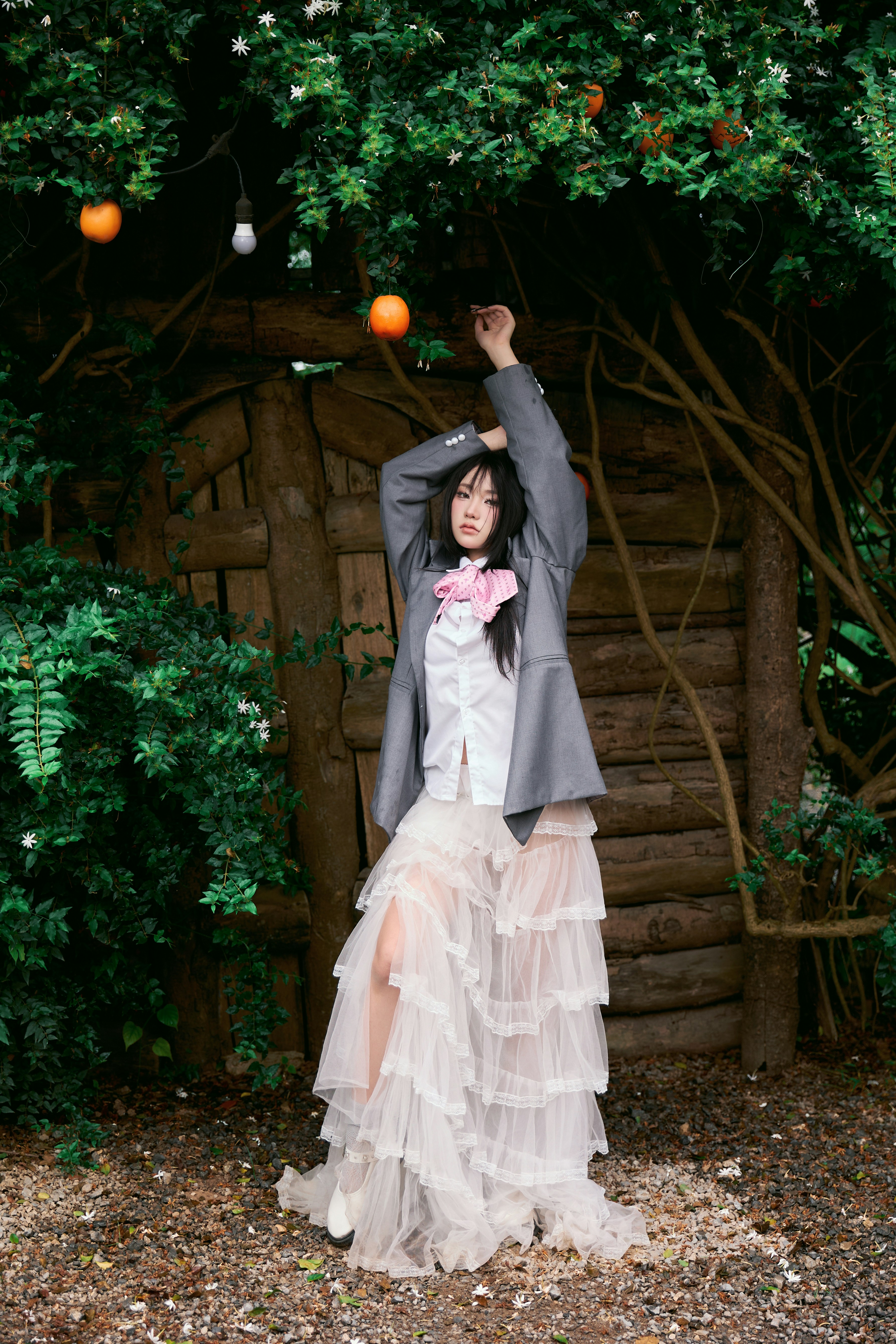 Hidden Orchard dancer beneath hanging orbs and ivy
