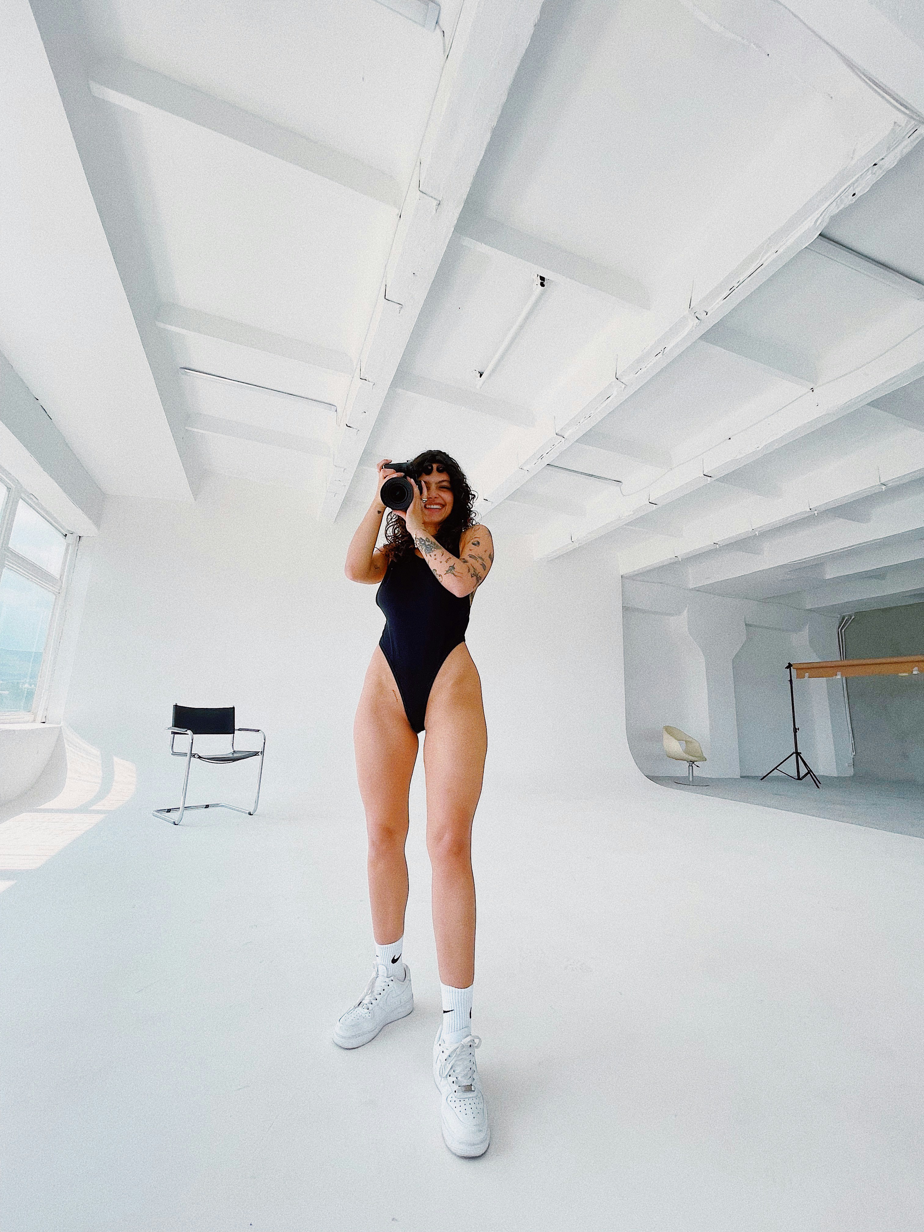 Center Stage in a Bright Studio: The Model with a Camera