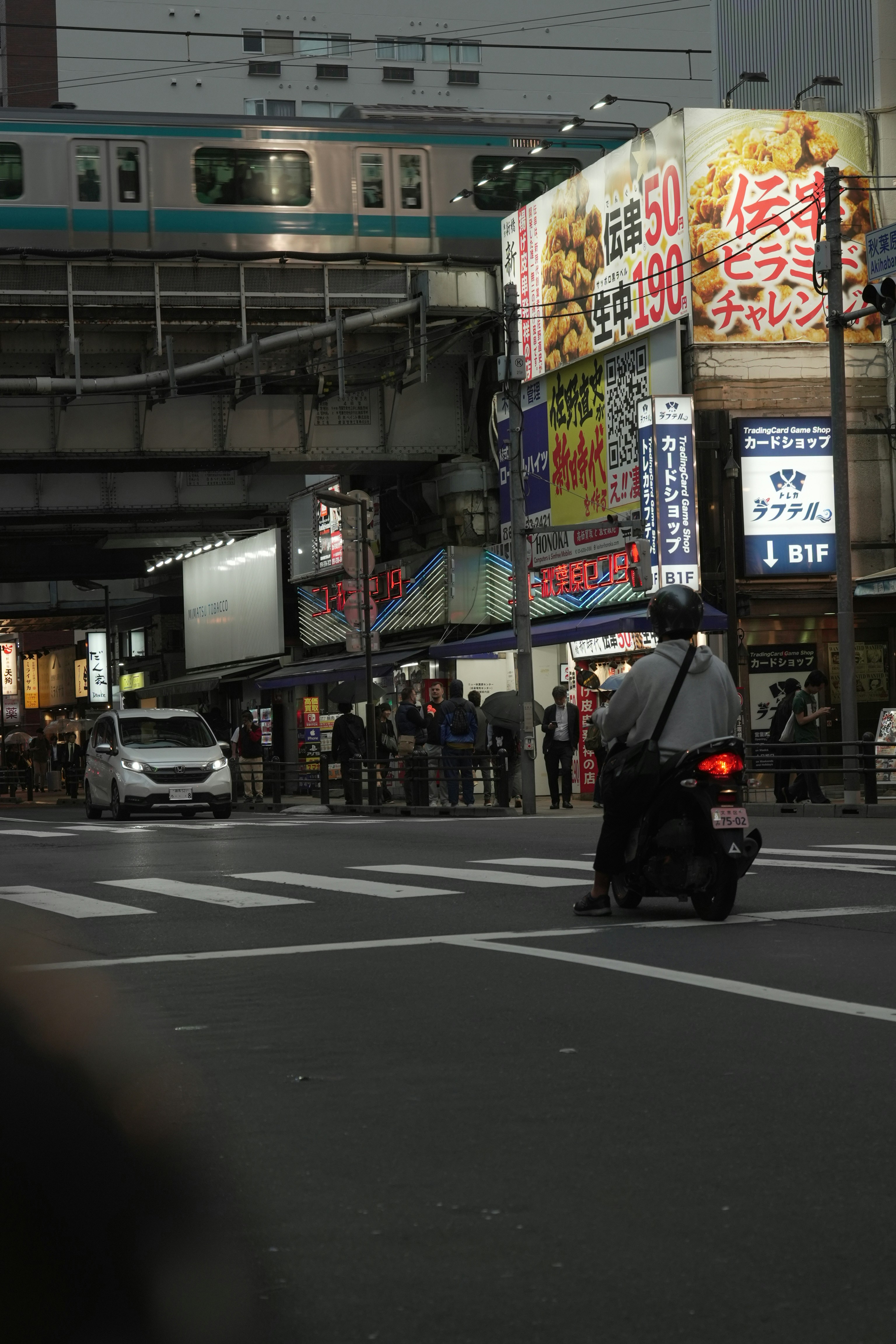 City Pulse at Dusk: Neon Signs and Crossing Lights