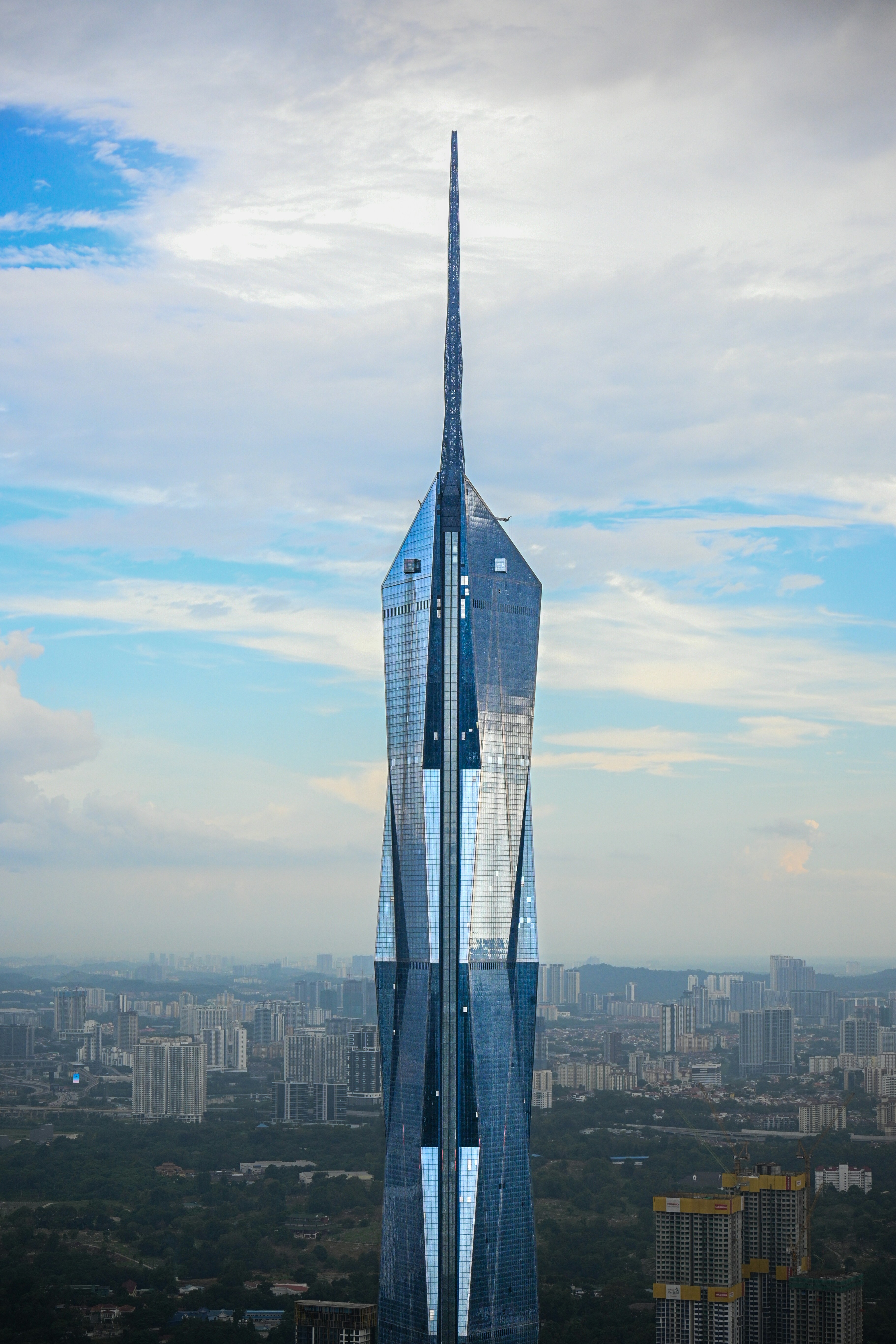 Skyward Spire: A Glass Monolith Cutting Through Cityscape