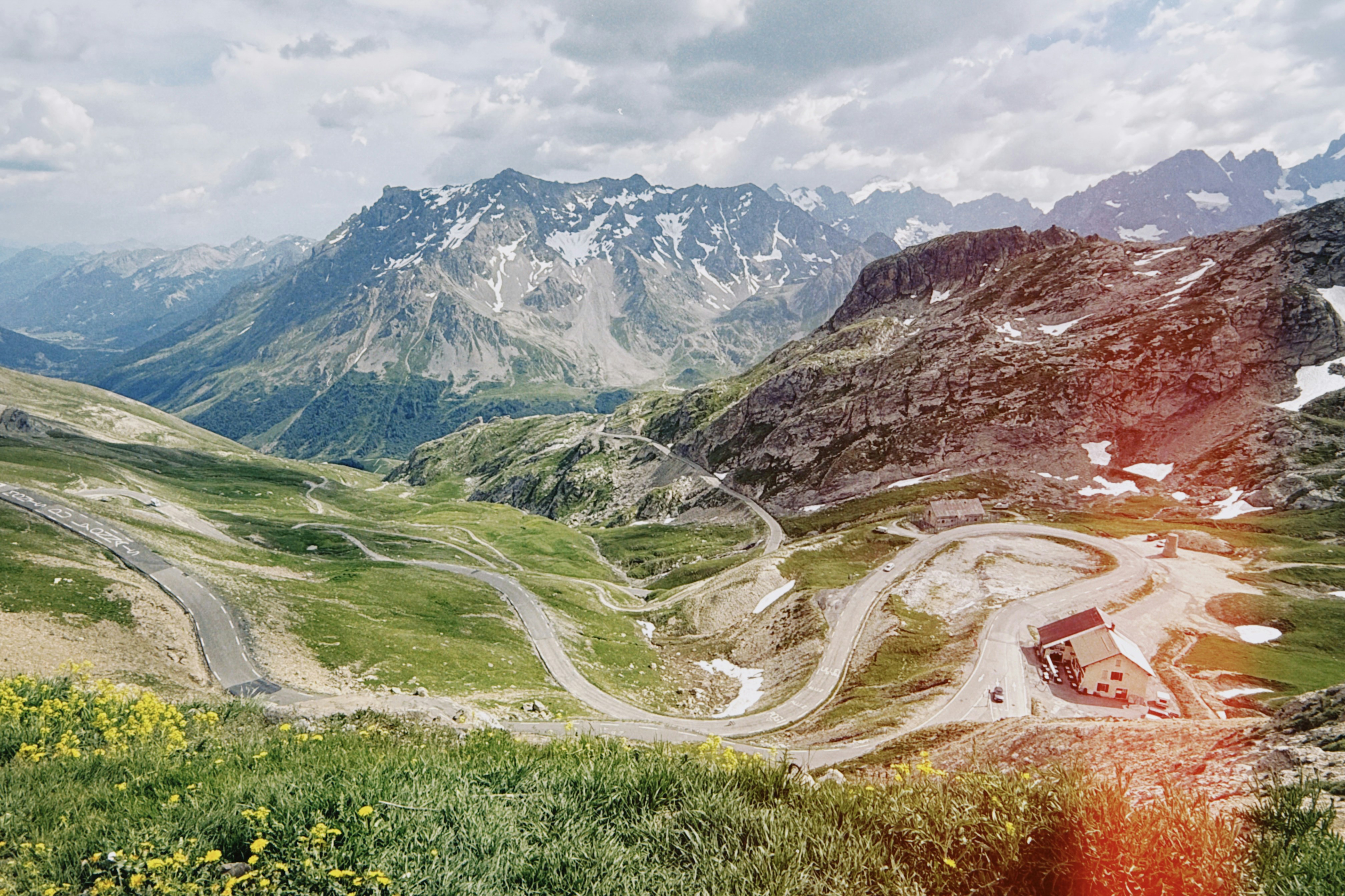 Switchback Serenade: Alpine Road Winding Through Summit Pastures