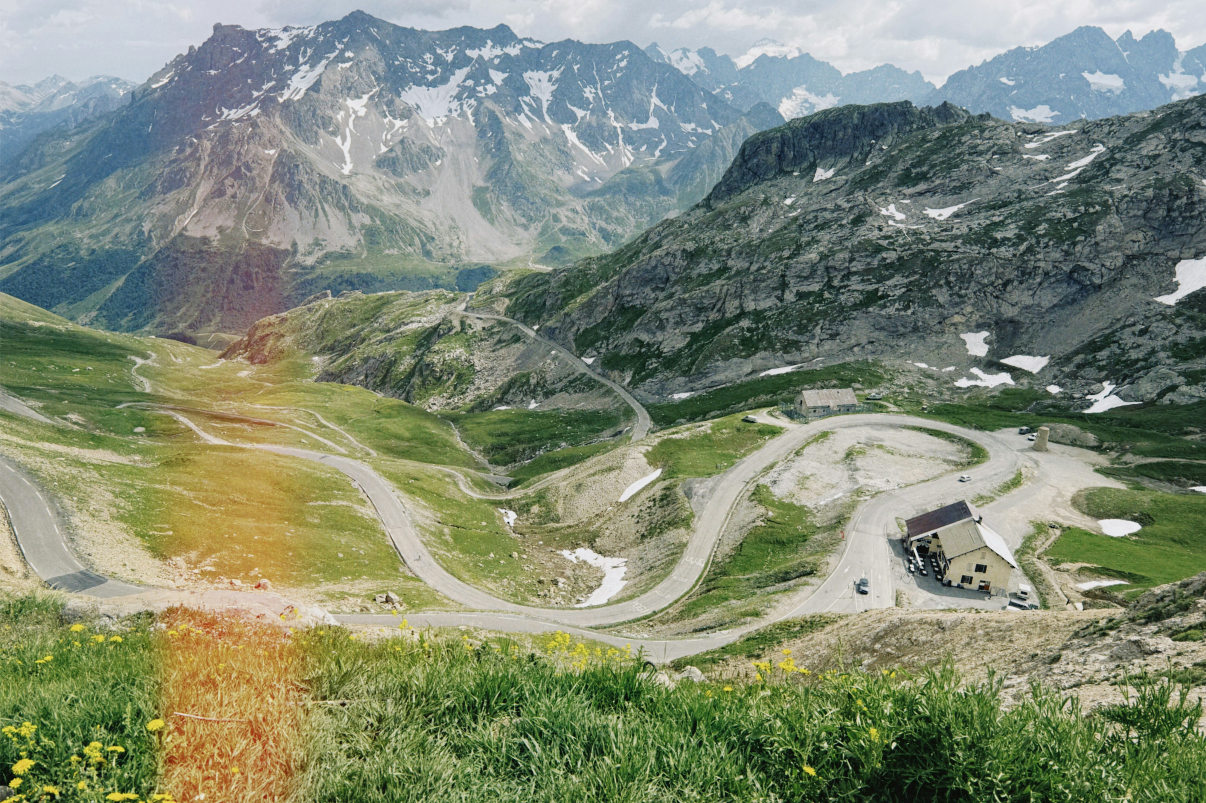 Switchbacks Beneath Snow-Kissed Peaks: A Mountain Road Odyssey