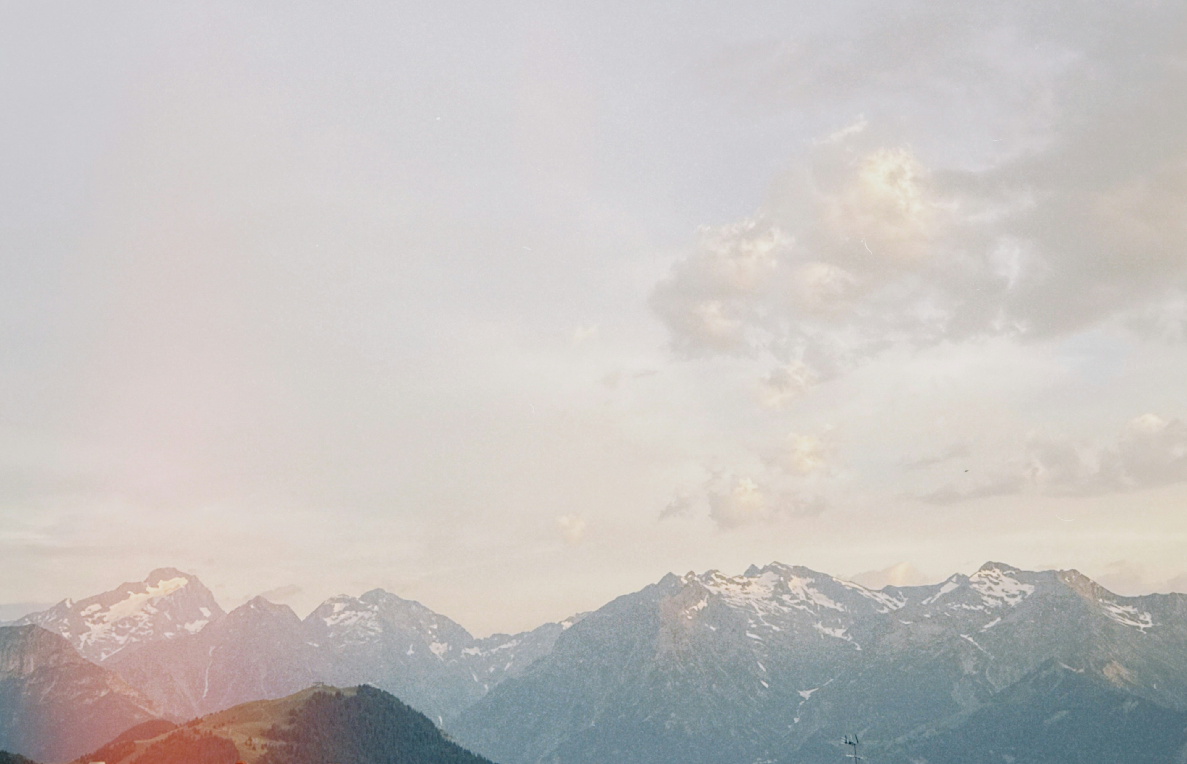 Snow-kissed ridge under a pastel high-altitude sky