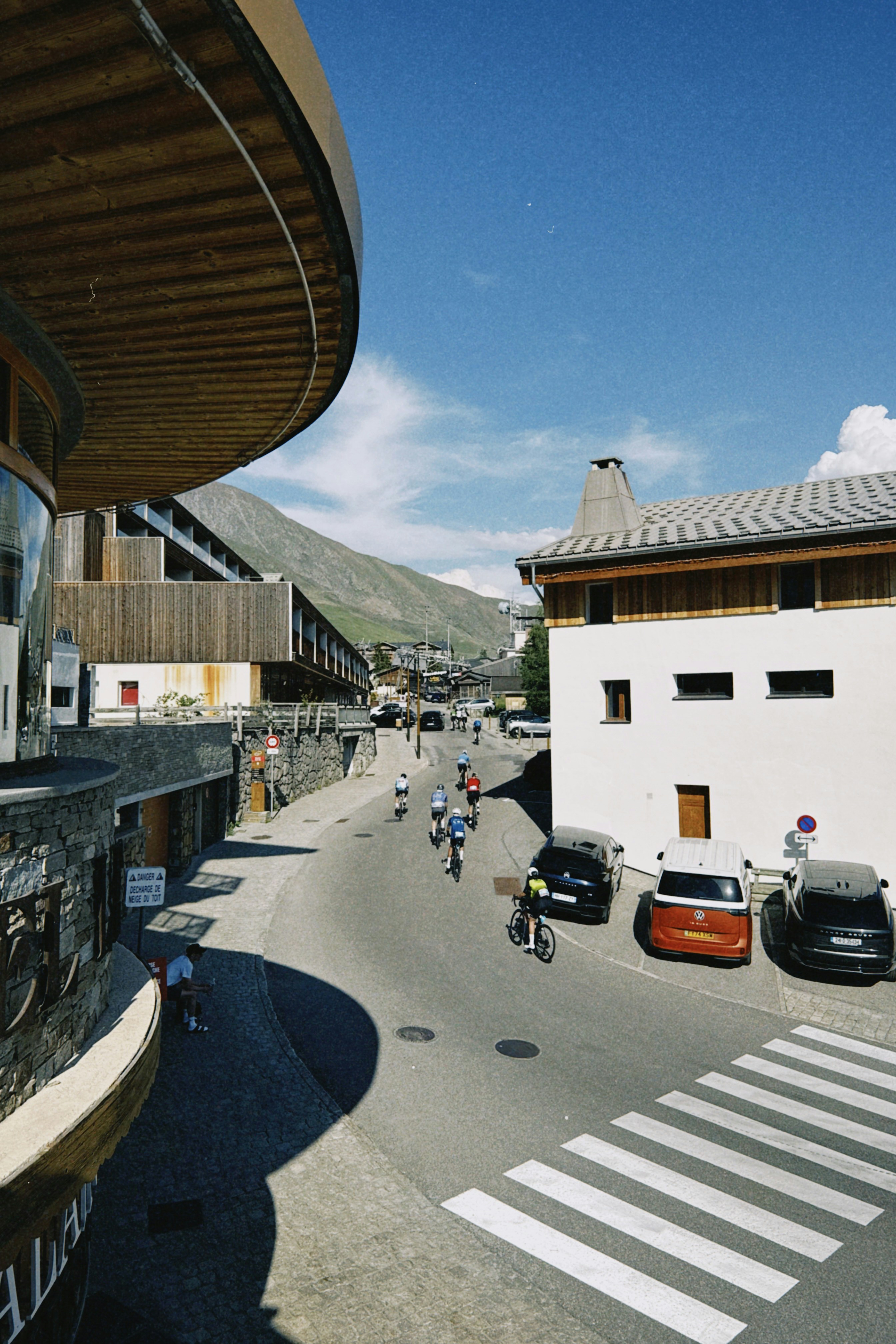 Mountain Village Cyclists in a Sunlit Main Street