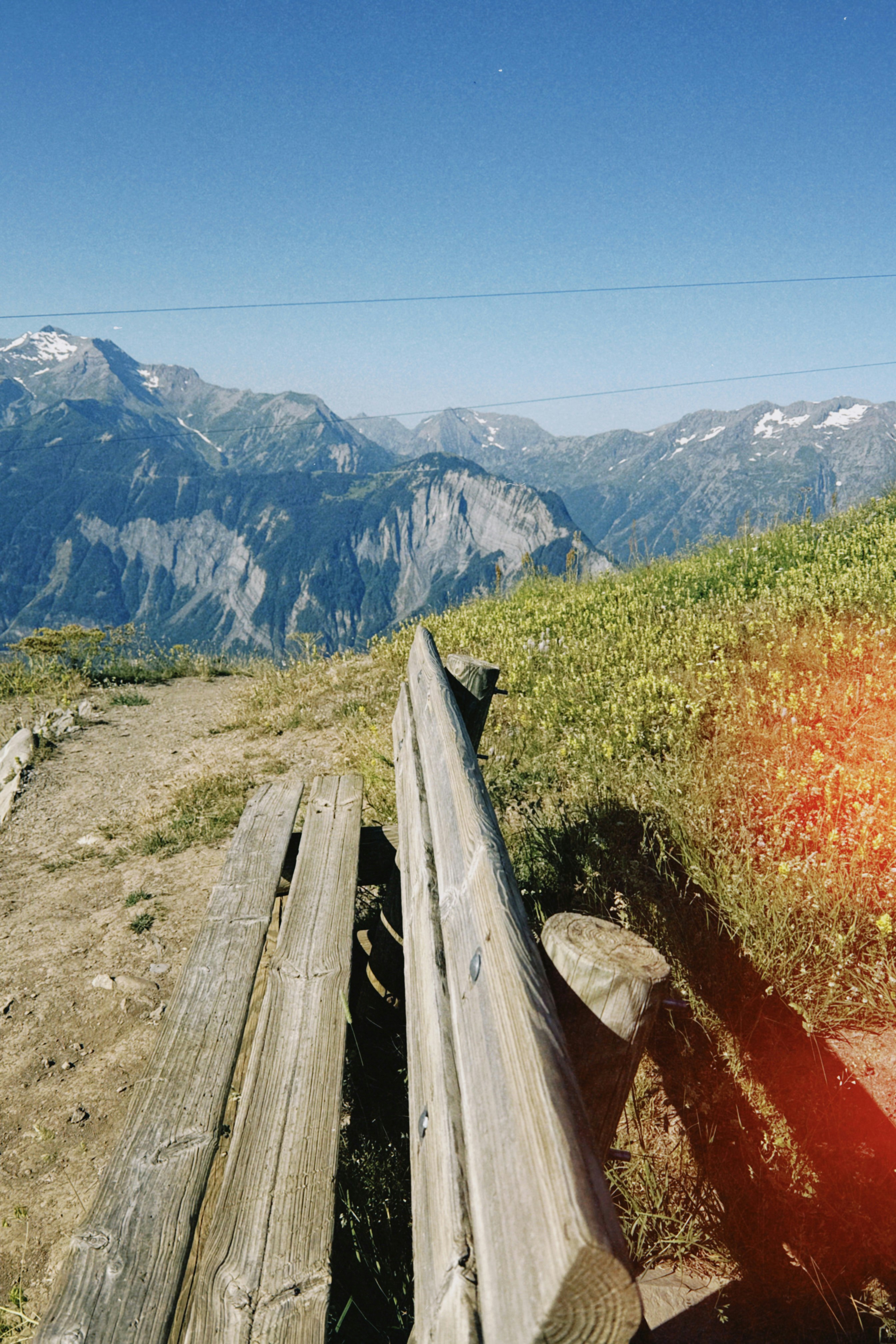 Echoes of the Pass: A Weathered railing toward Alpine Horizons