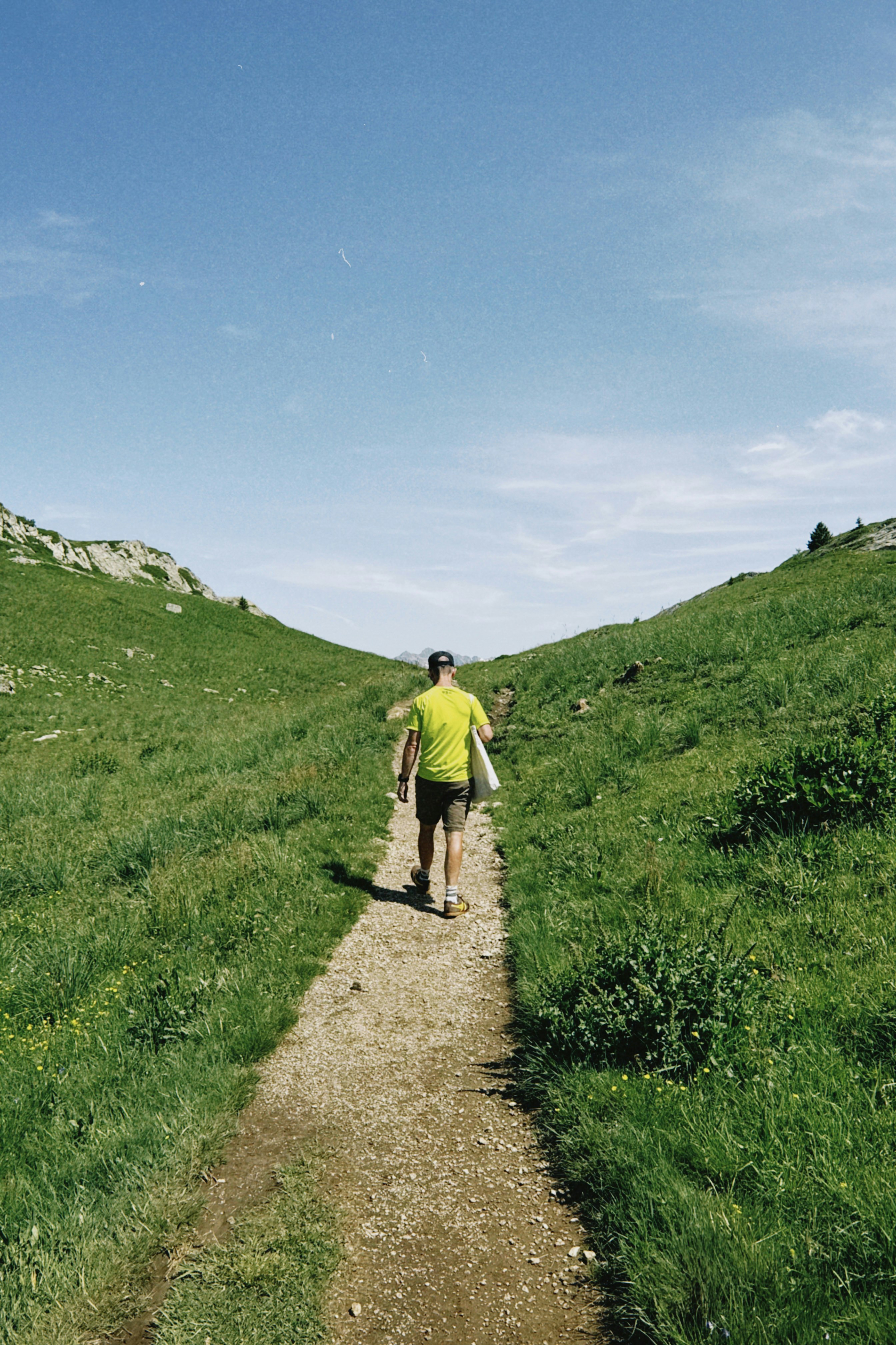 Hiker on a Sunlit Alpine Path