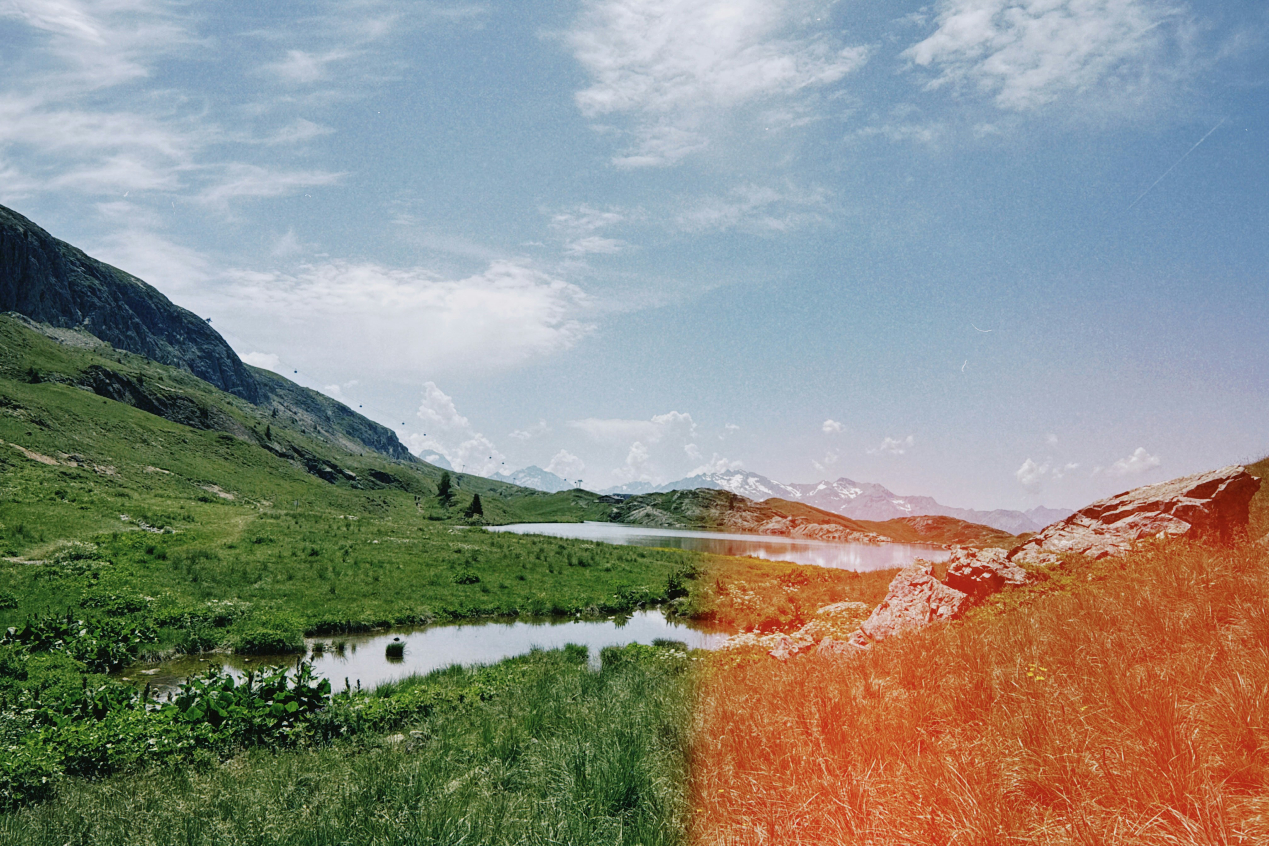 Hidden valley under a pale blue sky with alpine stream