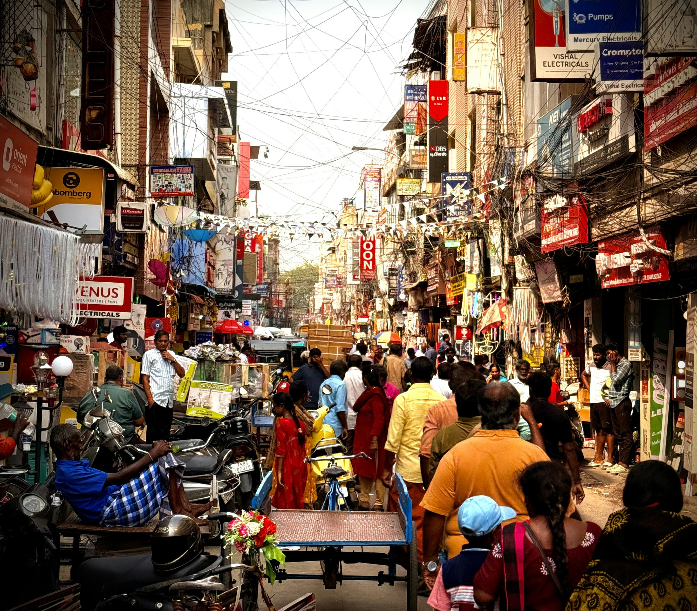 Vibrant Street Corridor: A Crowded Bazaar Breathes Color and Life