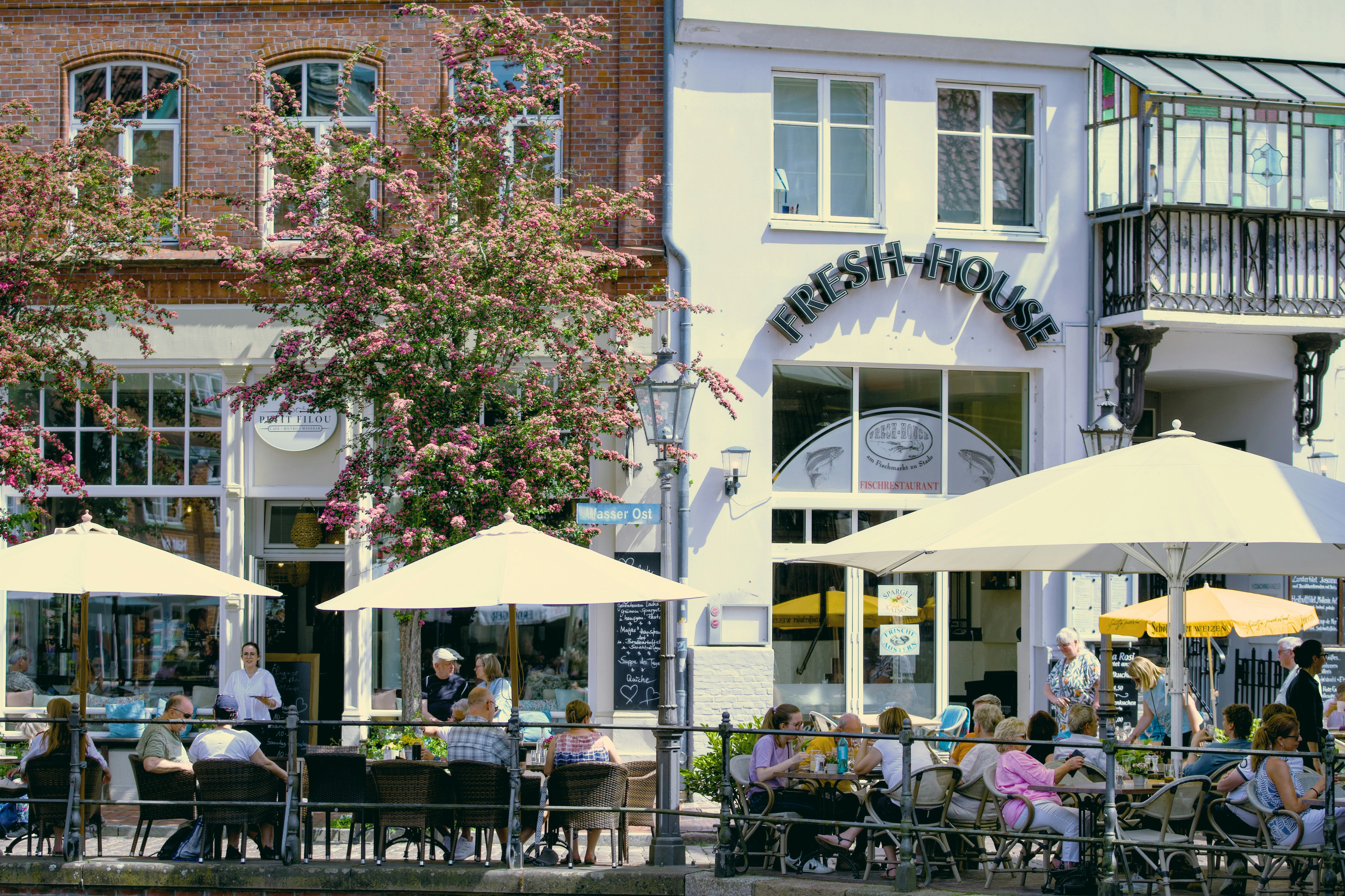 Café Terrace in a Sunlit Town Hangs Over the Street