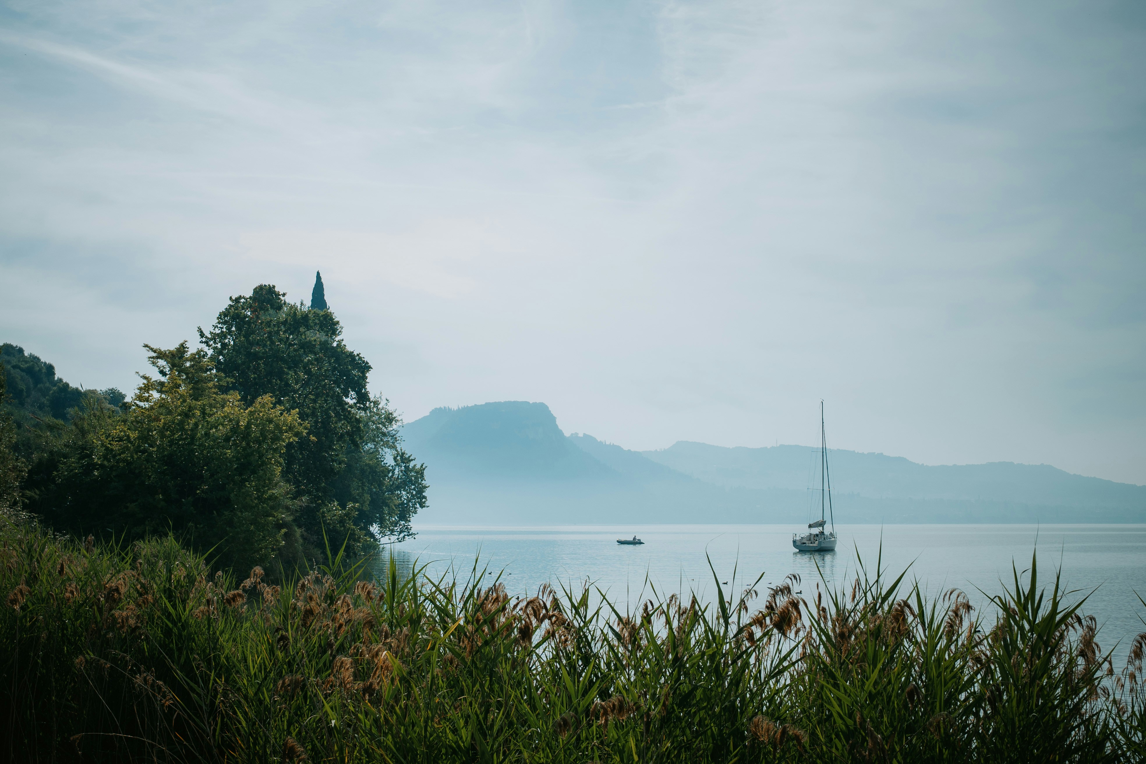 Calm Lake Vista with a Sailed Quiet Horizon