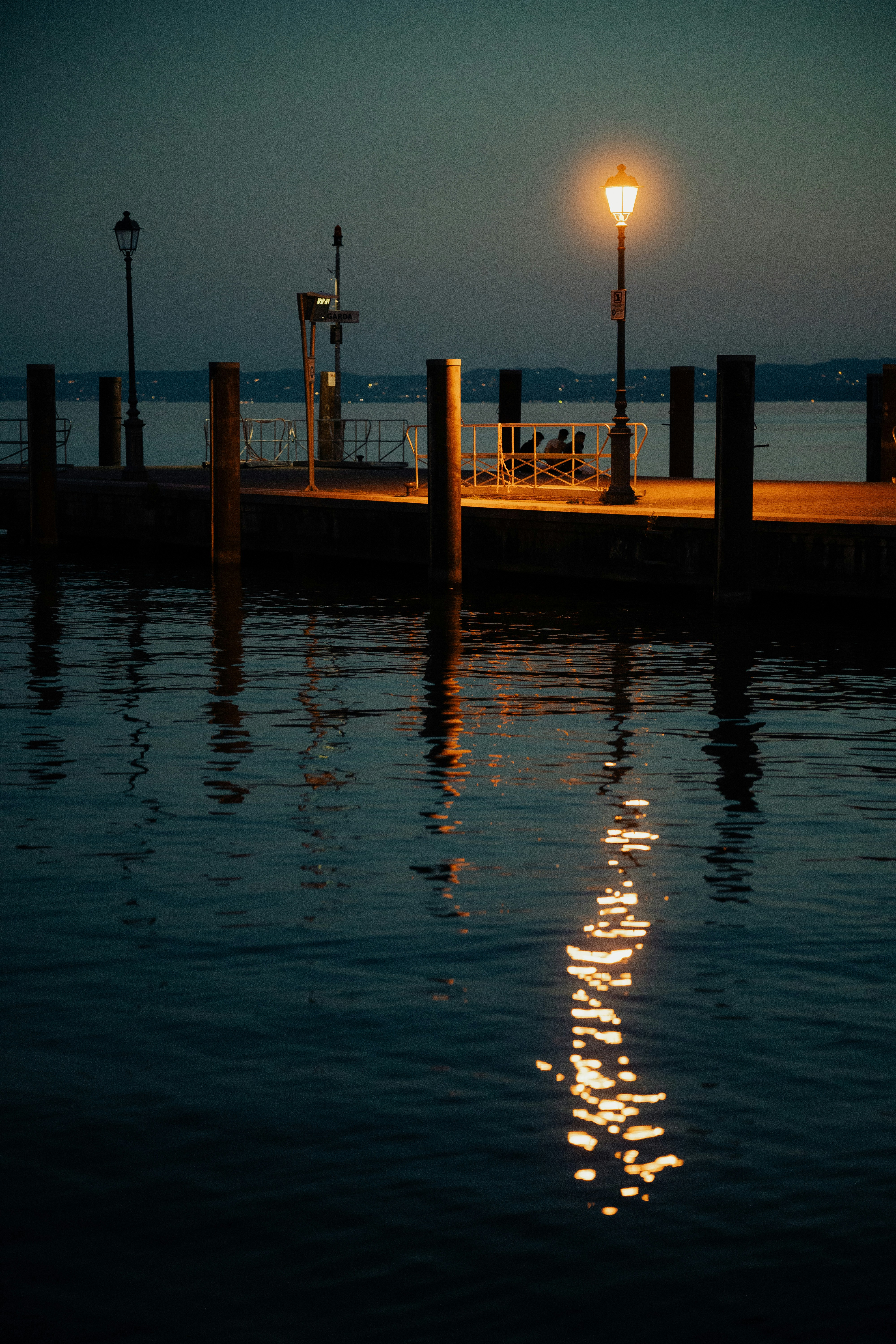 Luminous Pier at Dusk: A Quiet Walk Between Lamp and Water