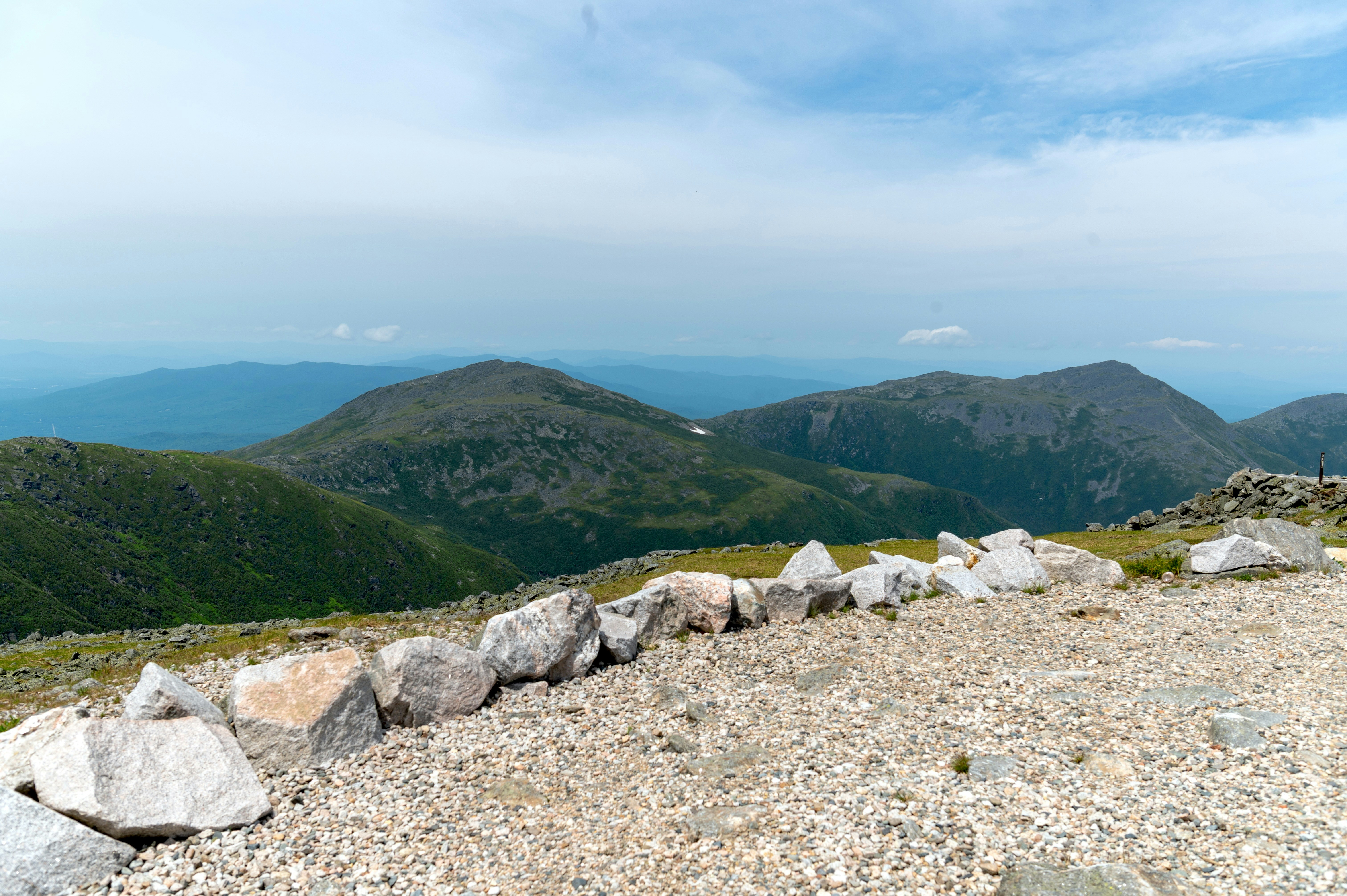 Rugged Mountain Rim: A Pebble-Strewn Plateau Looking Toward Distant Peaks