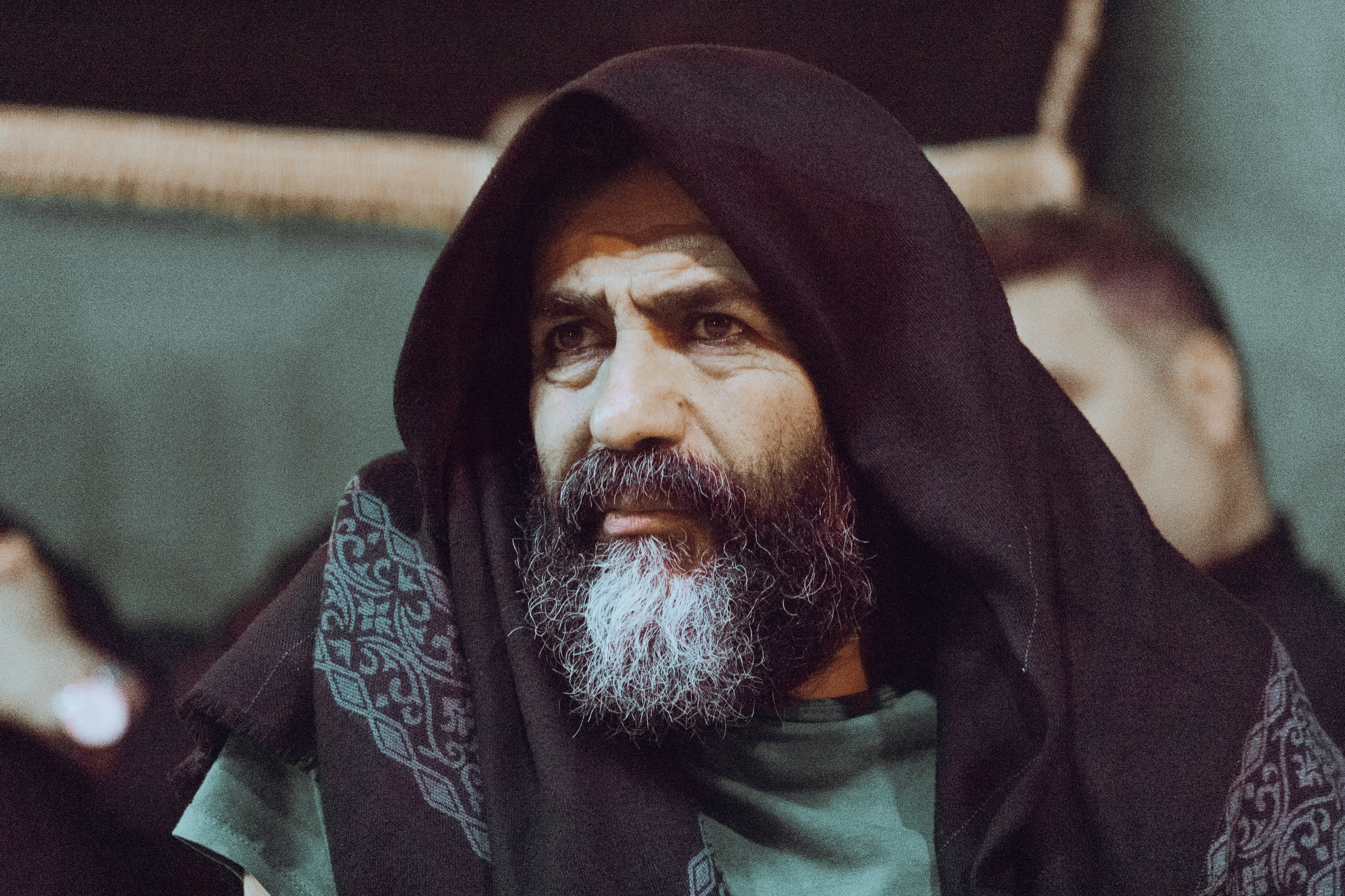 Bearded Reverie: A Hooded Figure in Quiet Contemplation