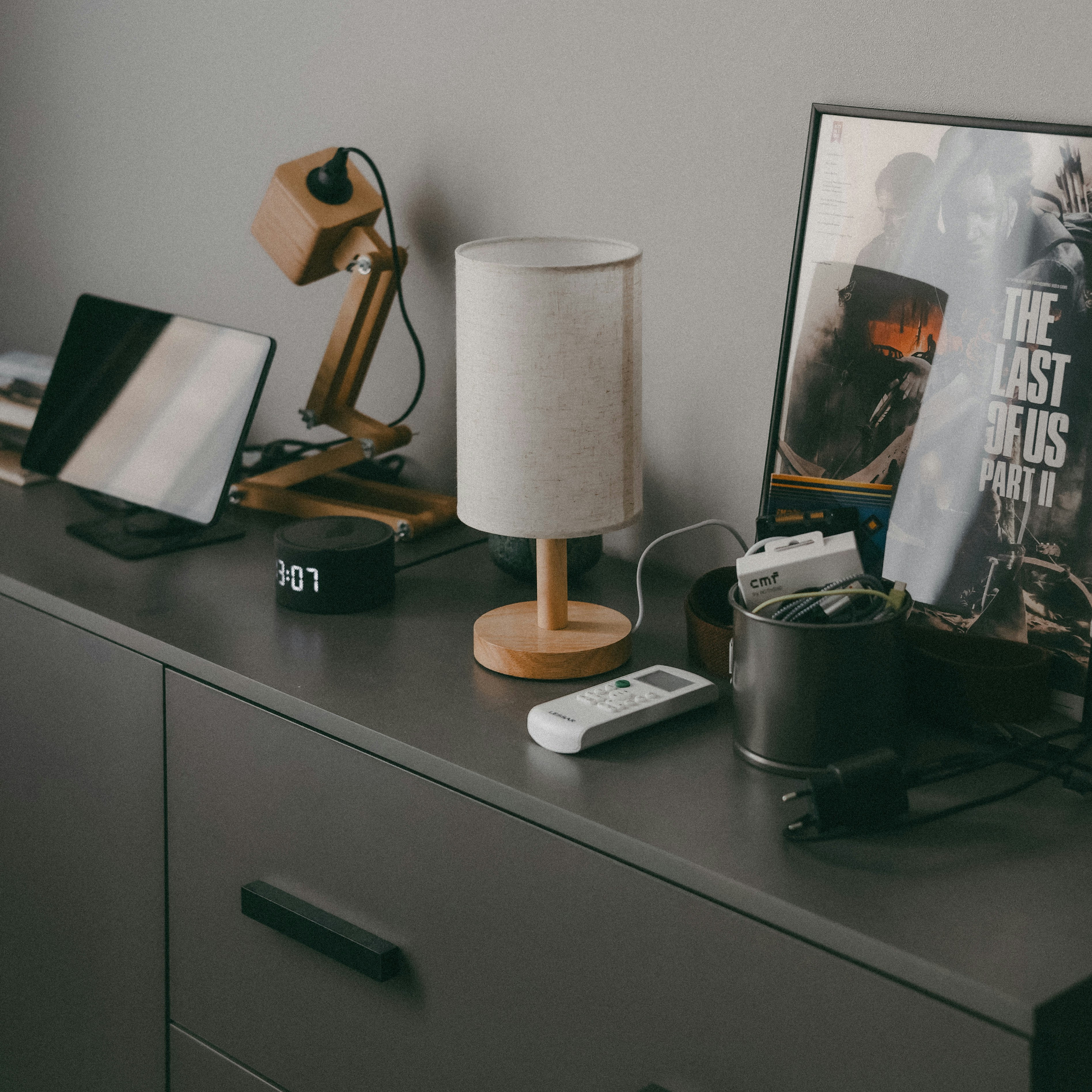 A Quiet Desk Still Life: Lamp, Tech, and Framed Movie Night