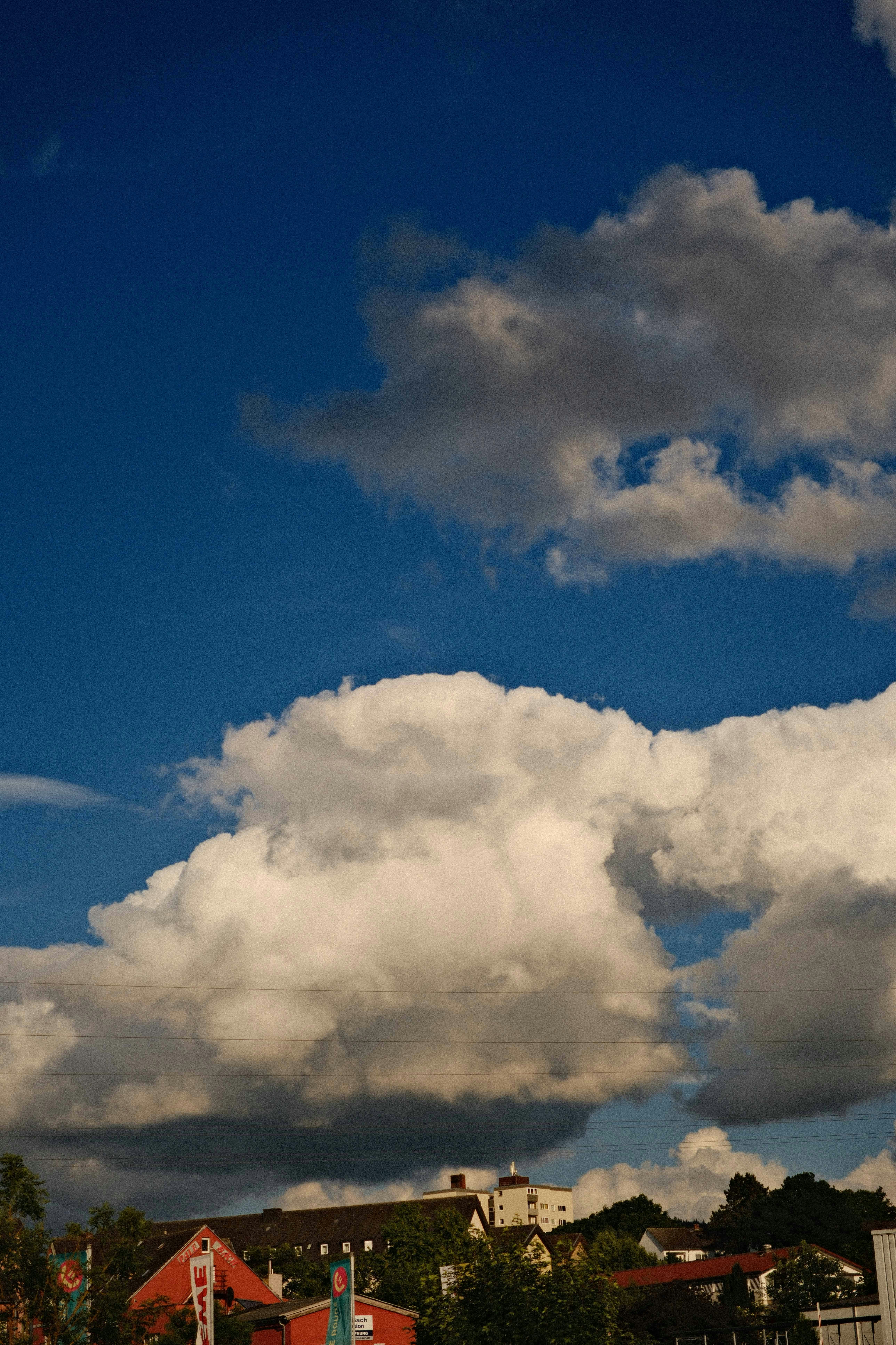 Clouds Over the Town: A Quiet Sky Meeting a Low Horizon