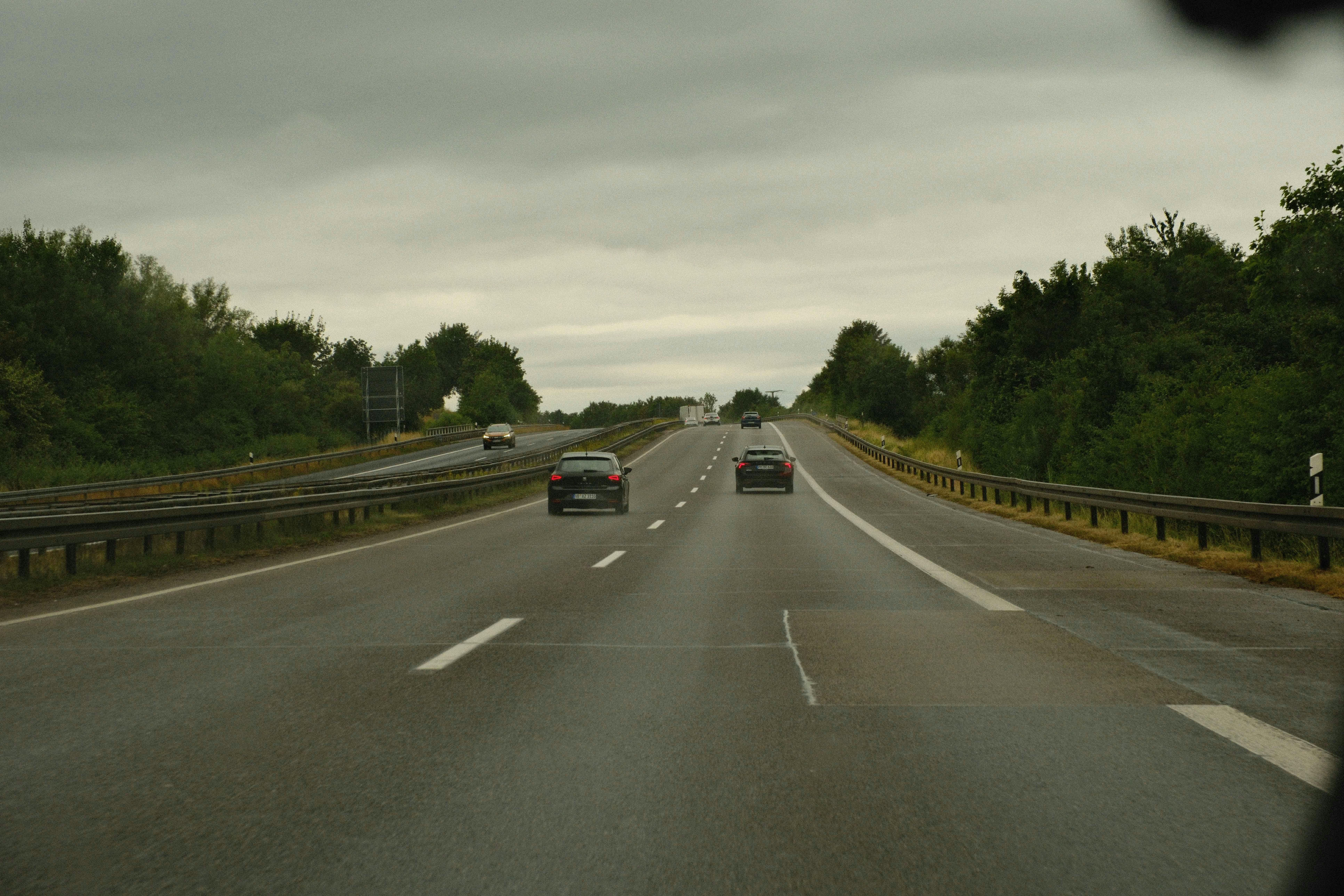 Mid‑Highway Convergence: Cars and Composure Beneath a Broad Sky