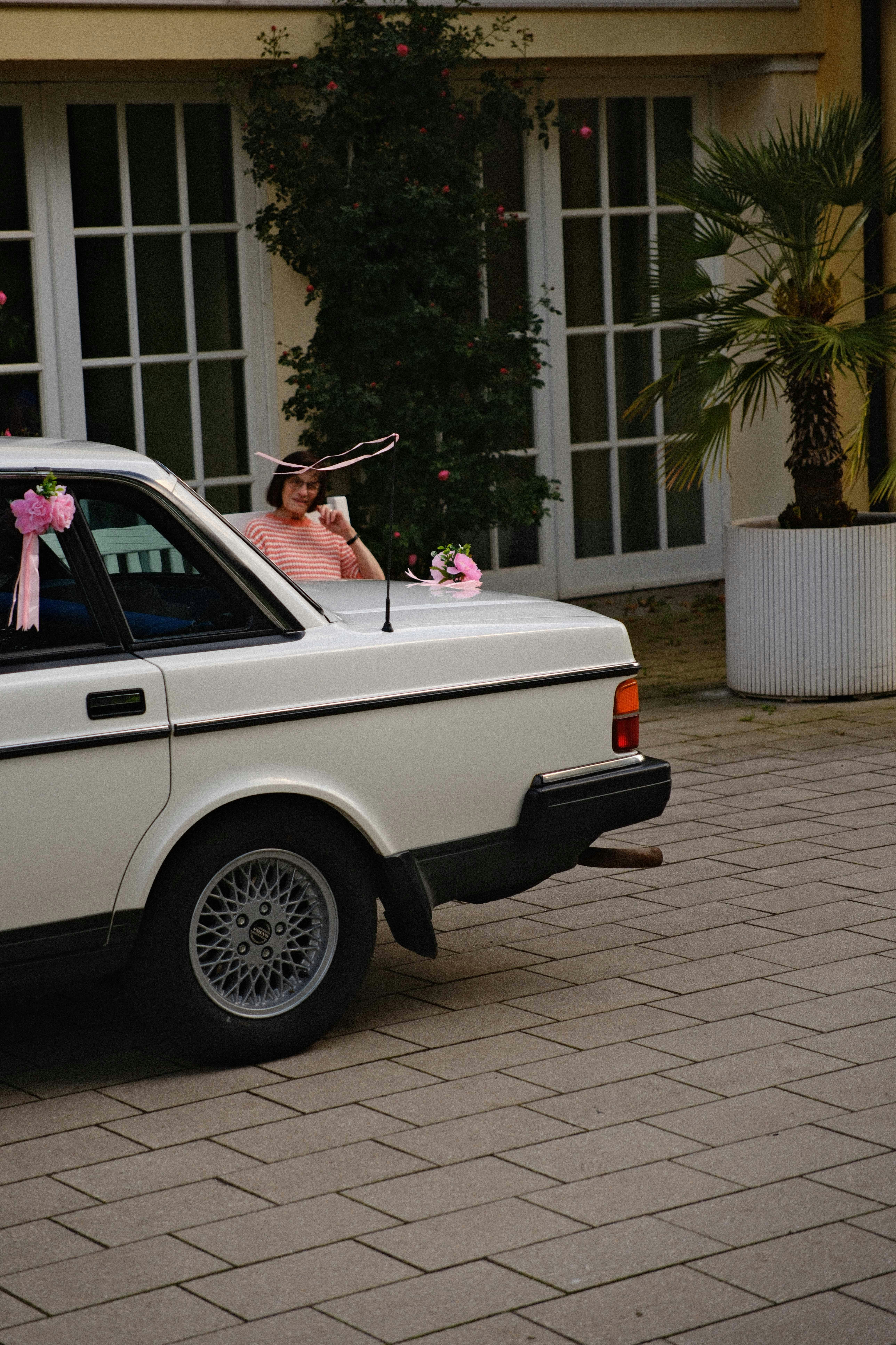 Pastel Parade: A vintage sedan adorned with ribbons and blooms