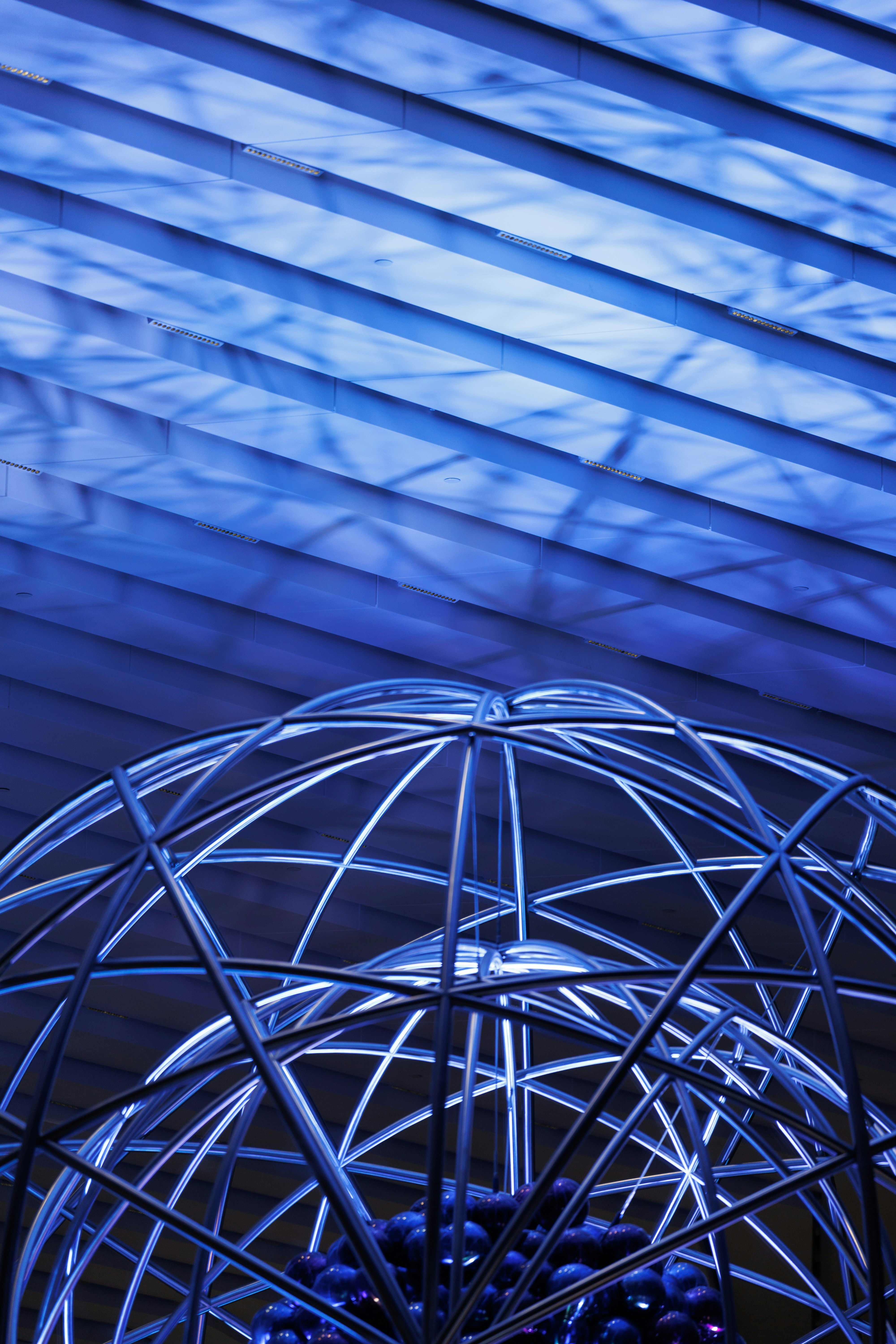 Blue Geodesic Orbs Under Louvered Skies