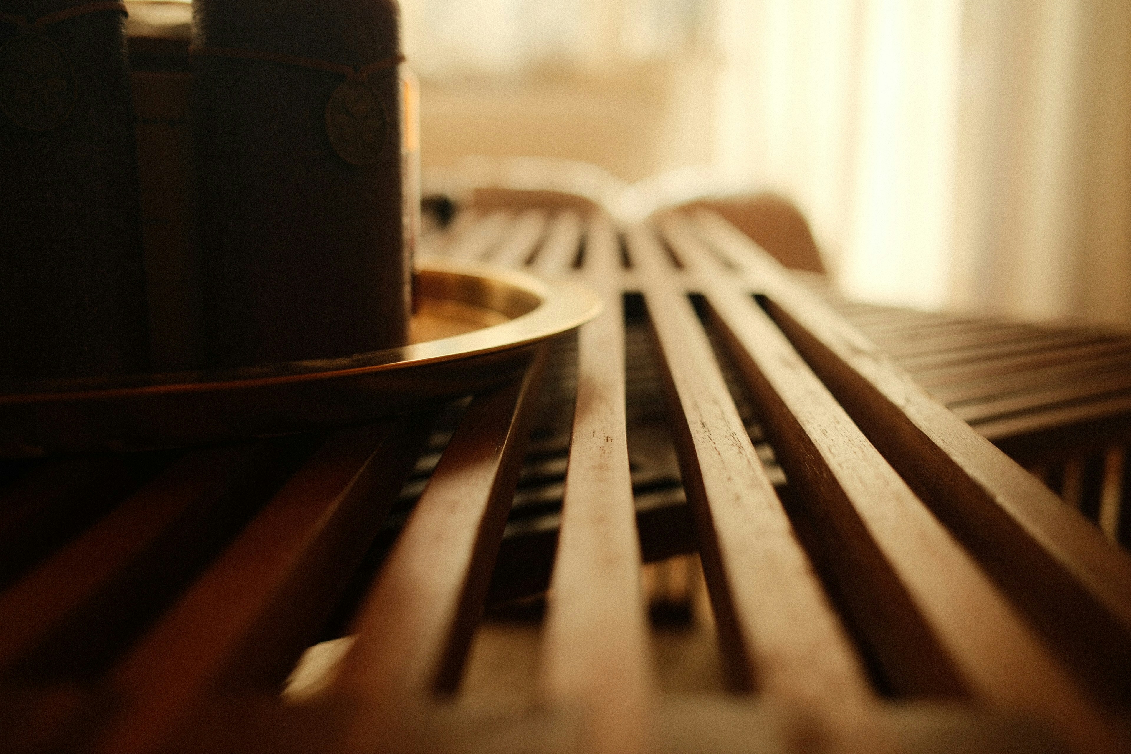 Warm lumen of carved slats: a close-up on coffee-bar geometry
