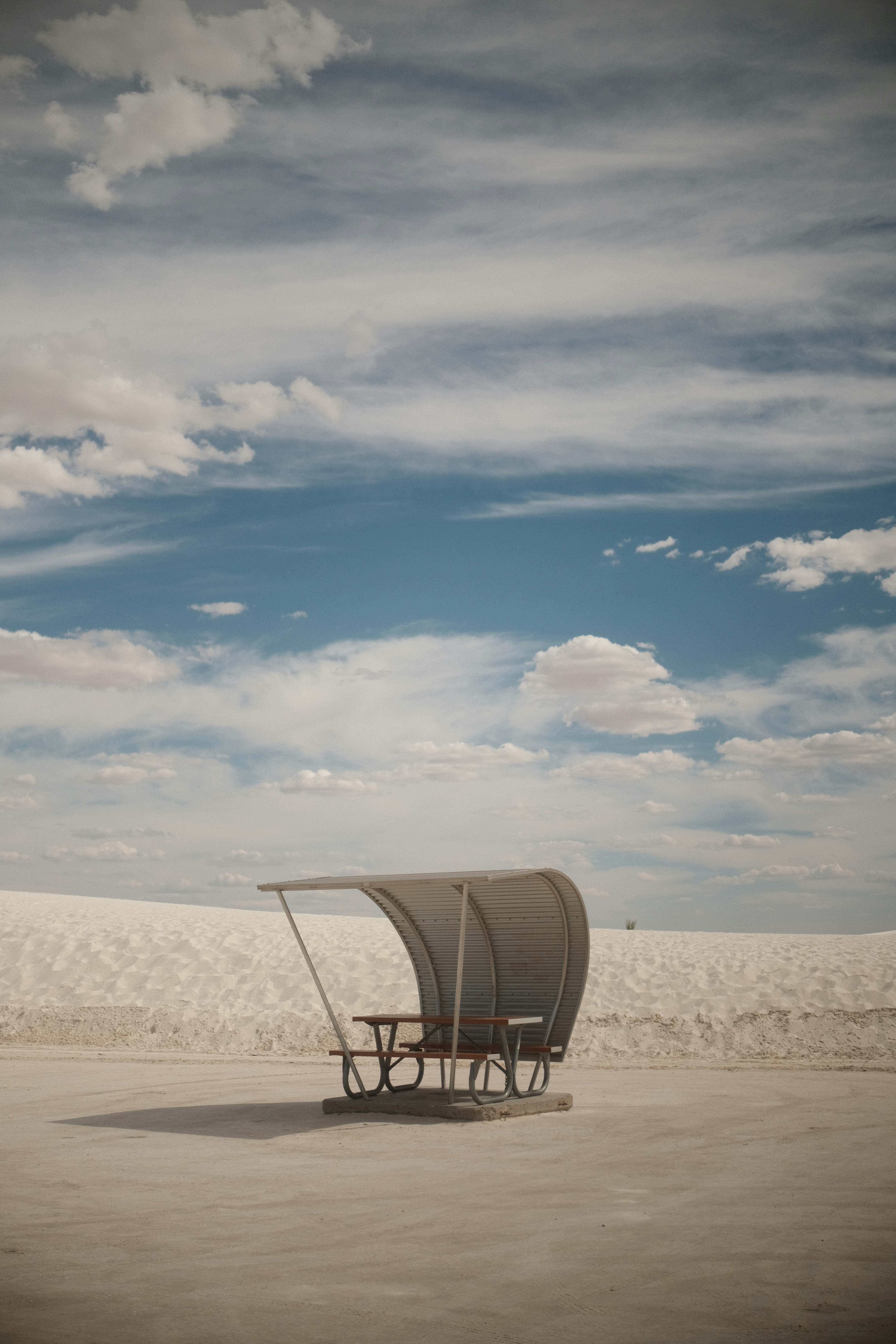 Solitary Shade: A Desert Bench Beneath Expansive Skies