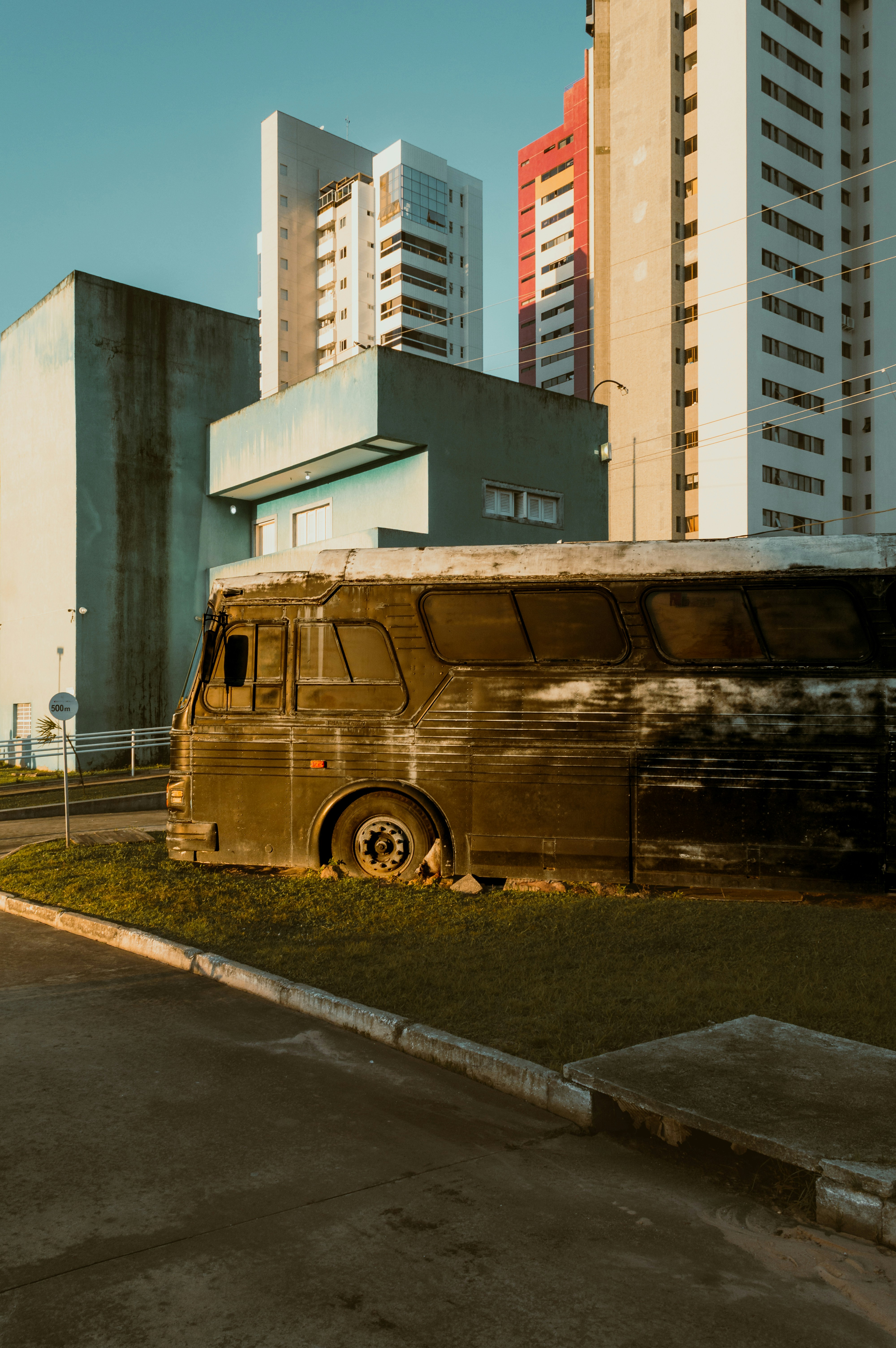 Abandoned Bus Against a City Horizon