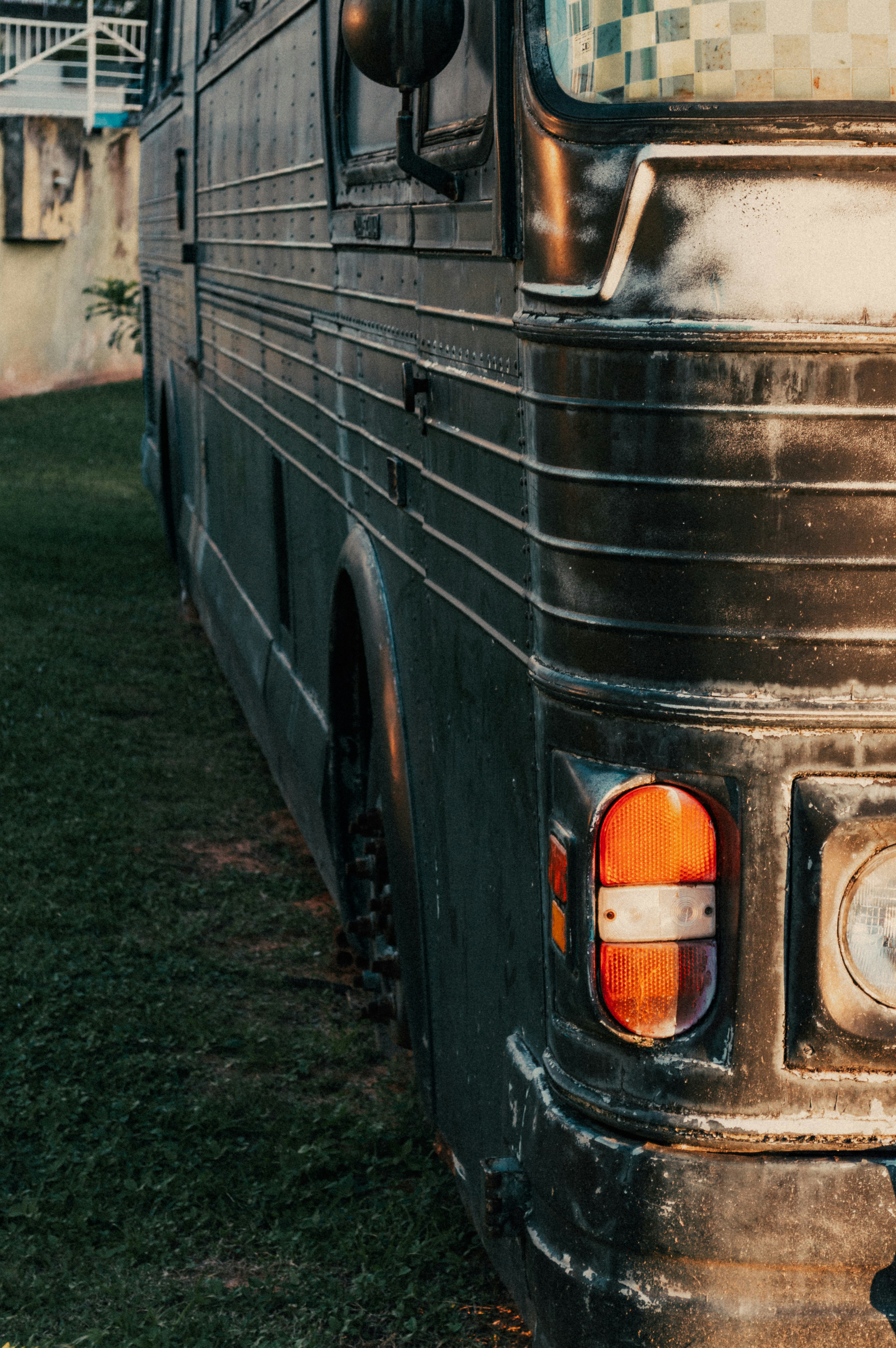 Weathered Bus Portrait: Rust, Reflections and a Quiet Side Street