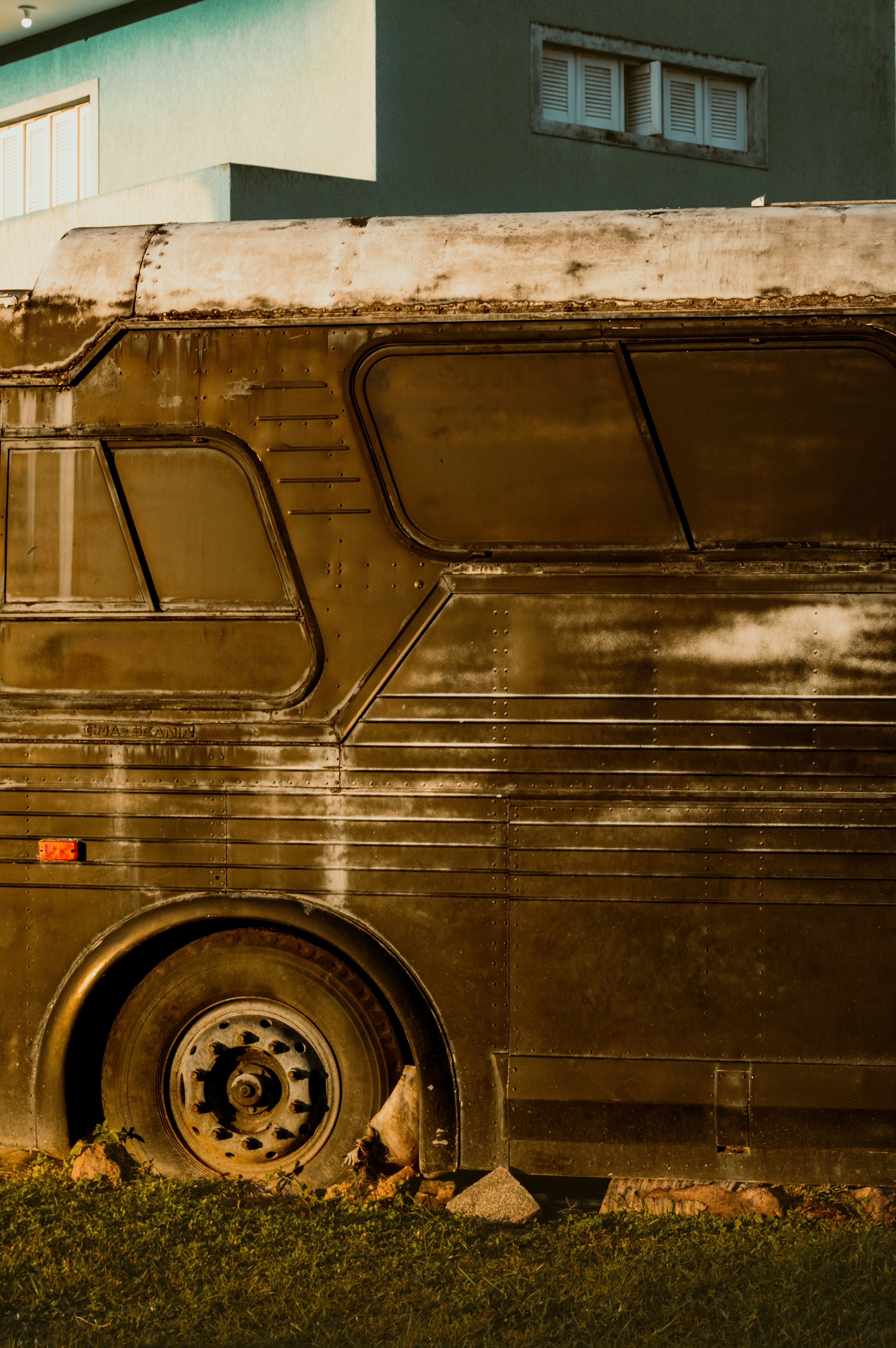 Sun-bleached Old Frontier: A Weathered Bus Resting in Quiet Light