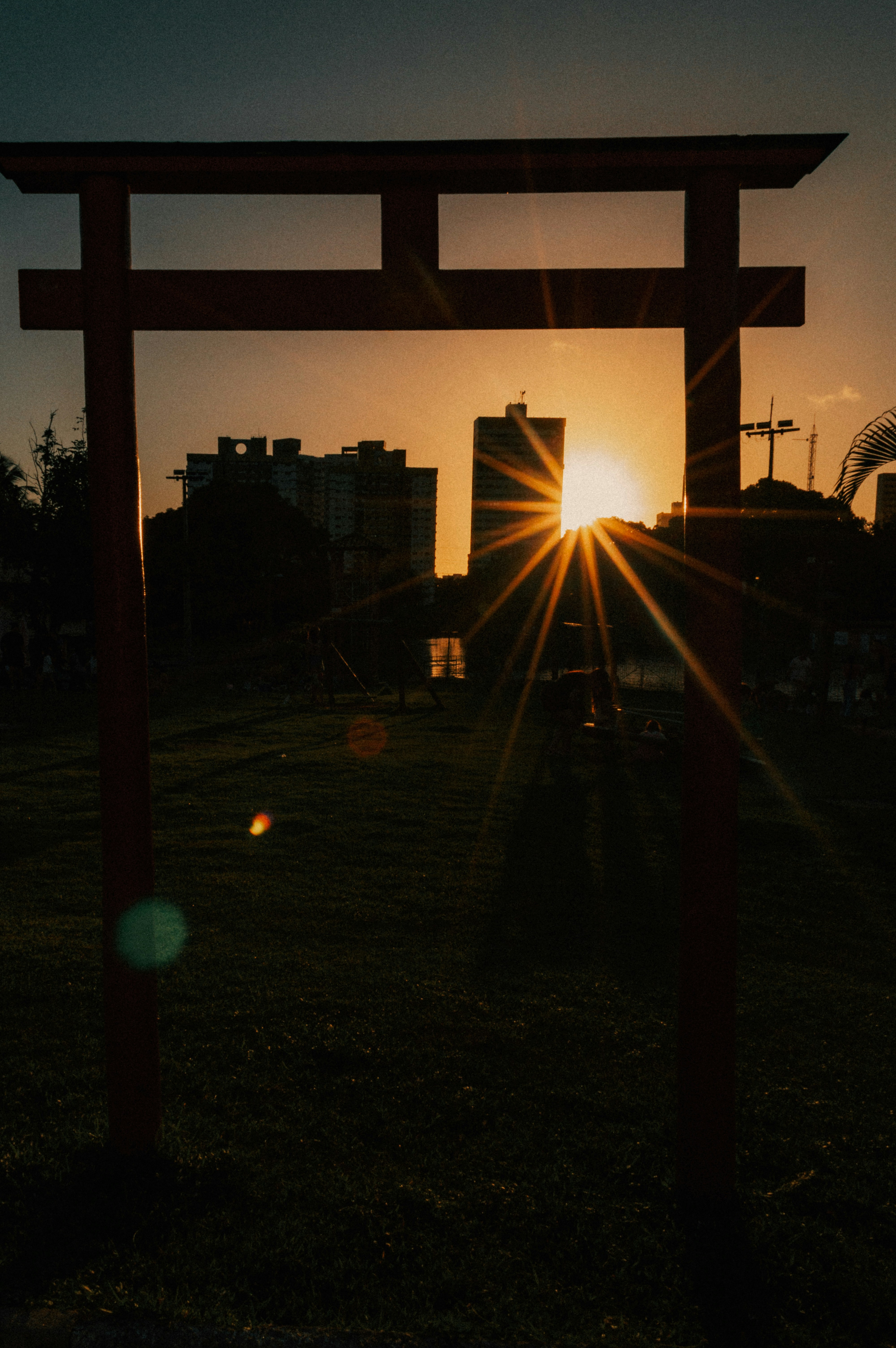 Sunburst Through a Shuttered Gate at Dusk