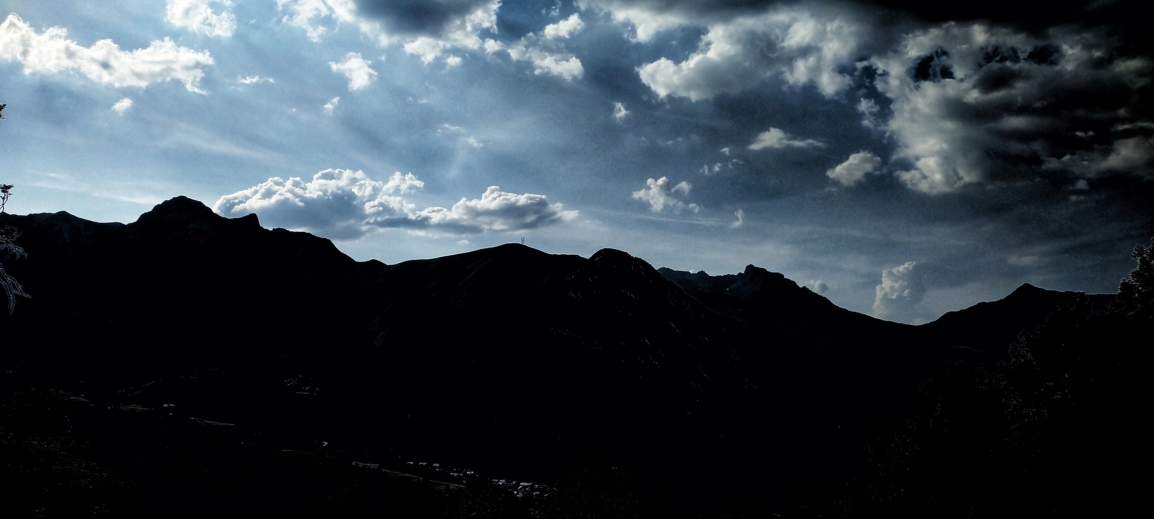 Twilight Ridge: A Silhouette Against a Stormy Sky