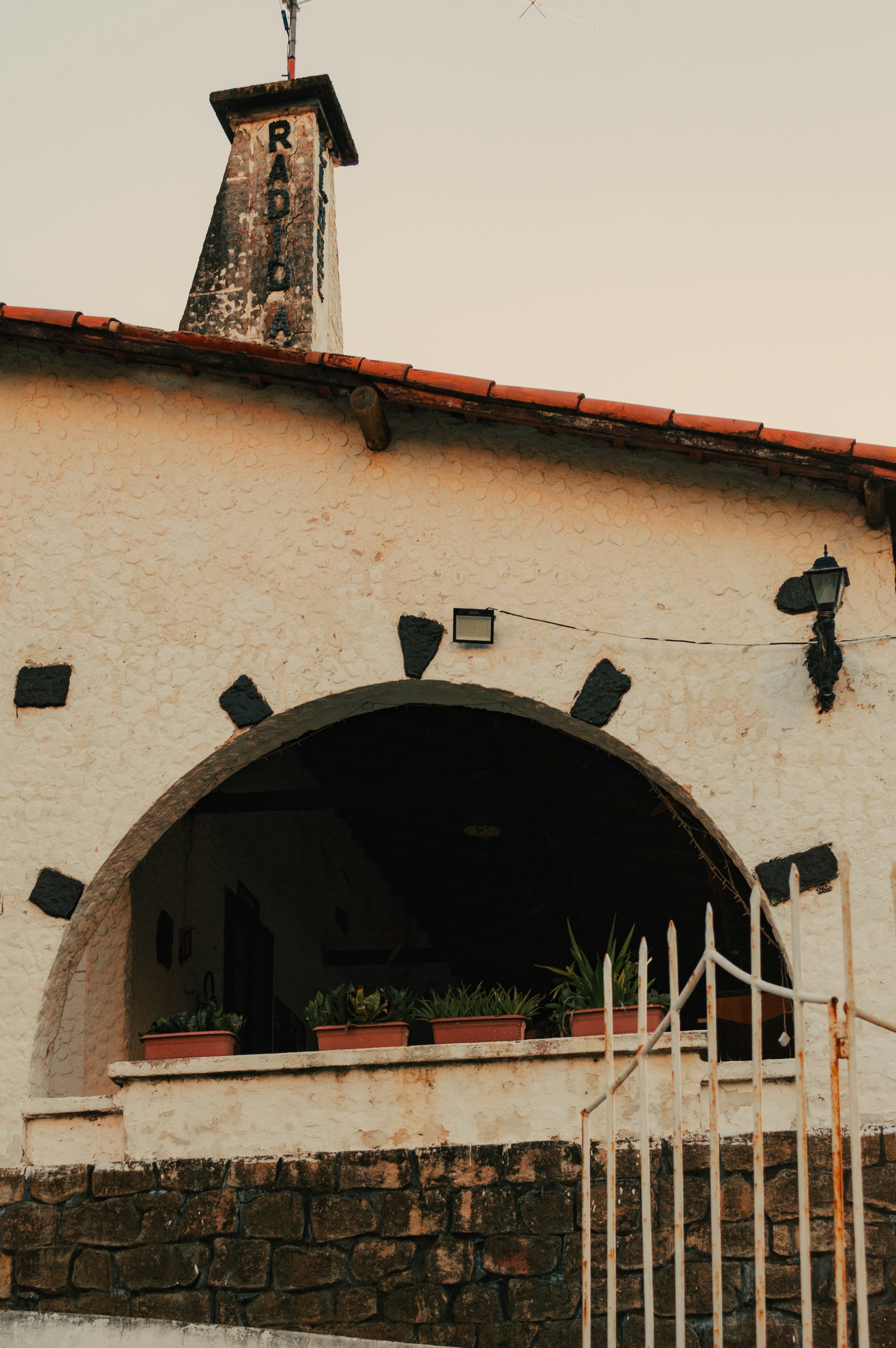 Arched Porch and Weathered Chimney: Quiet Corner of a Mediterranean Terrace