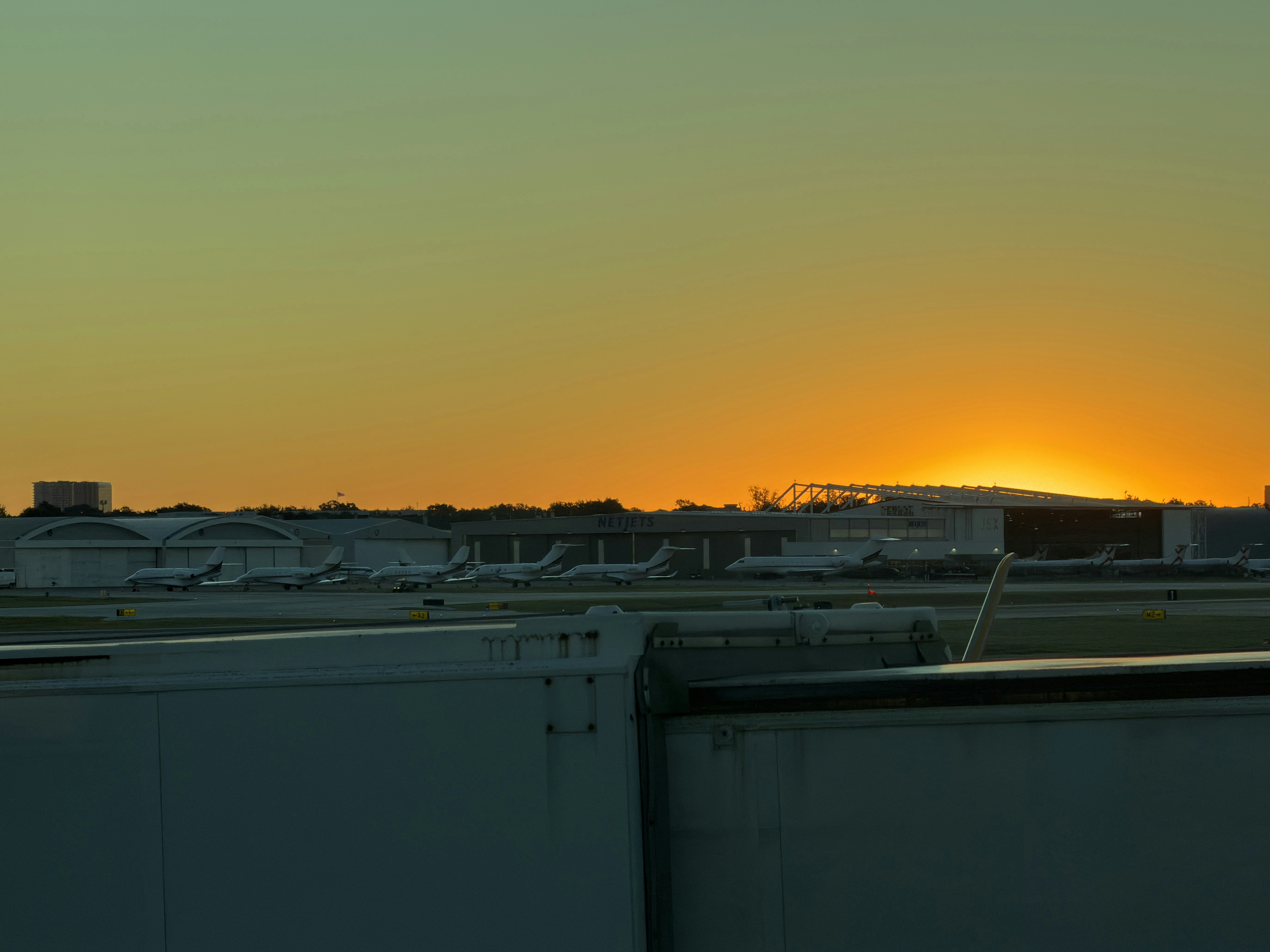 Sunset over the Terminal: Rooftops and Runways