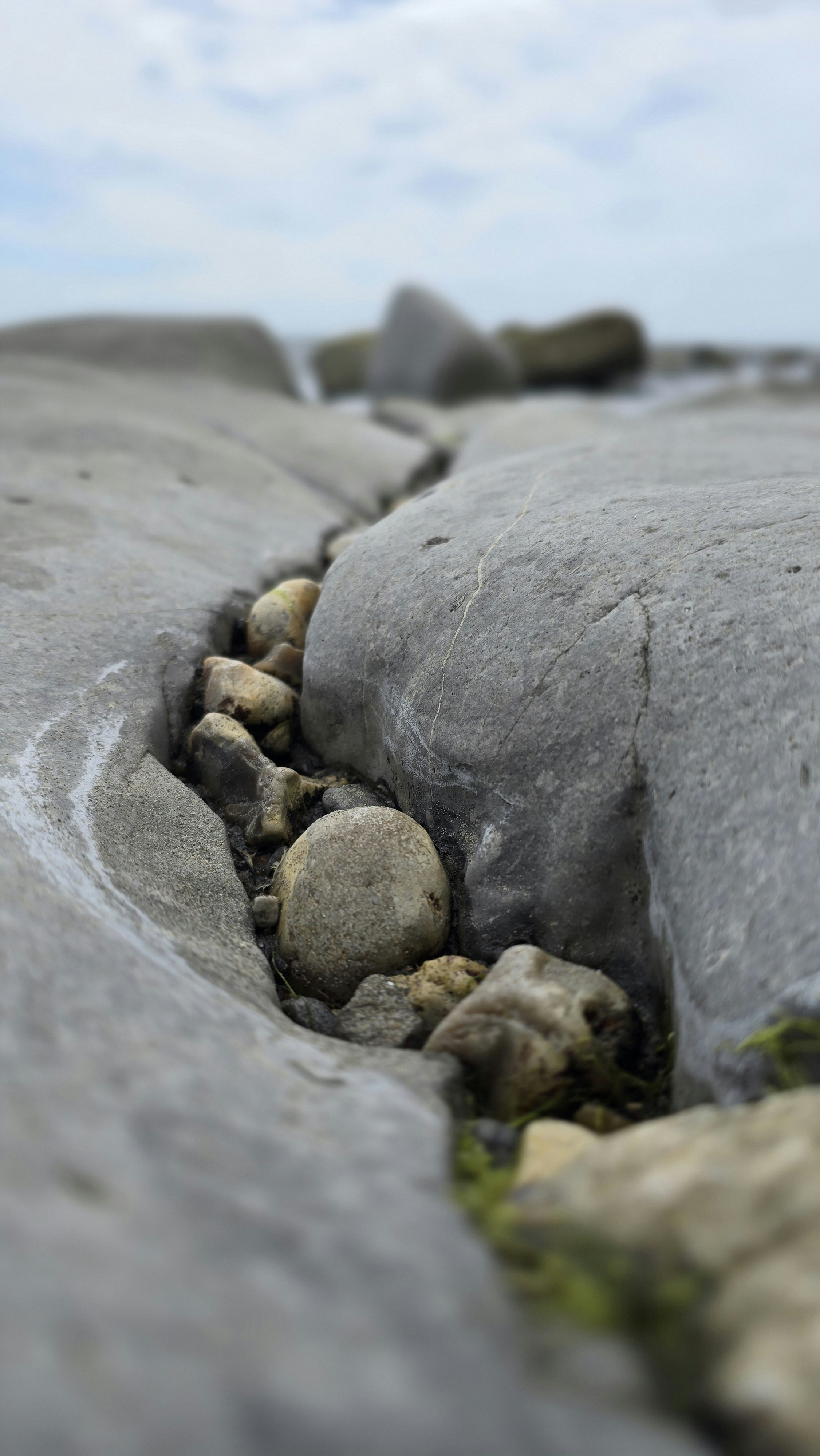Riven by Tide: A Quiet Channel of Weathered Stones