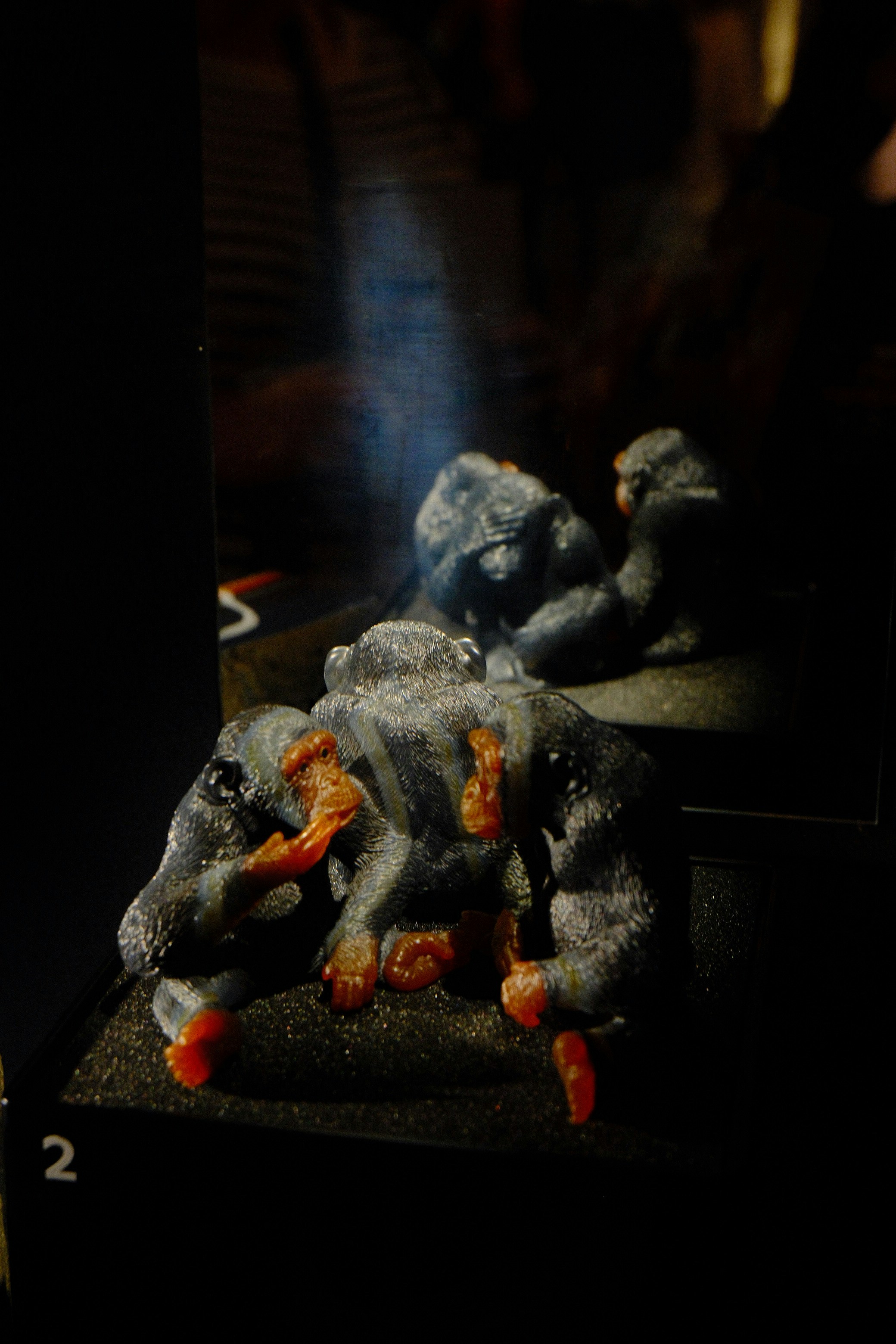 Charred Echoes: Embers of a Sculpted Ape in Velvet Darkness