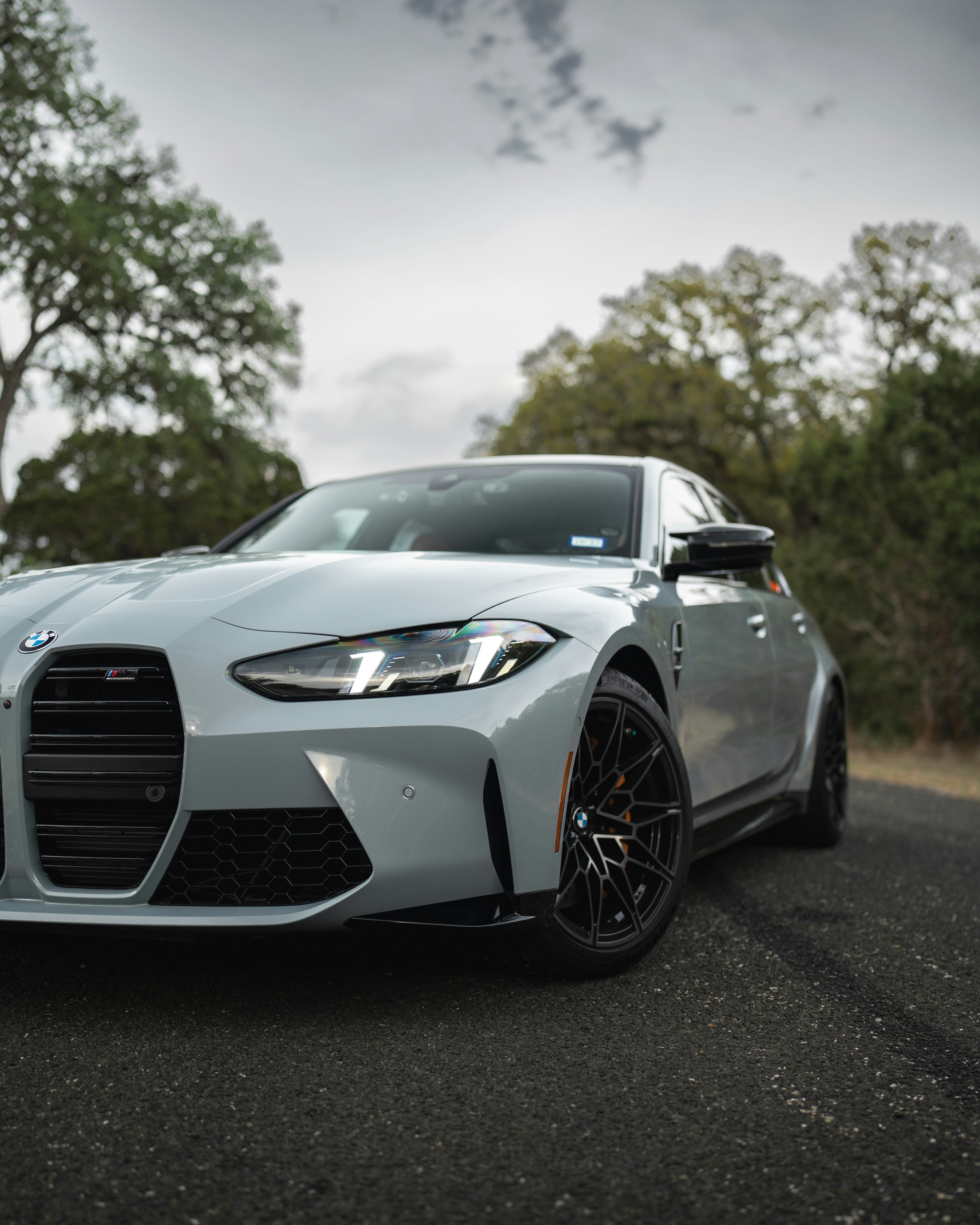 Low-angle Focus on a Grayscale BMW M Vehicle