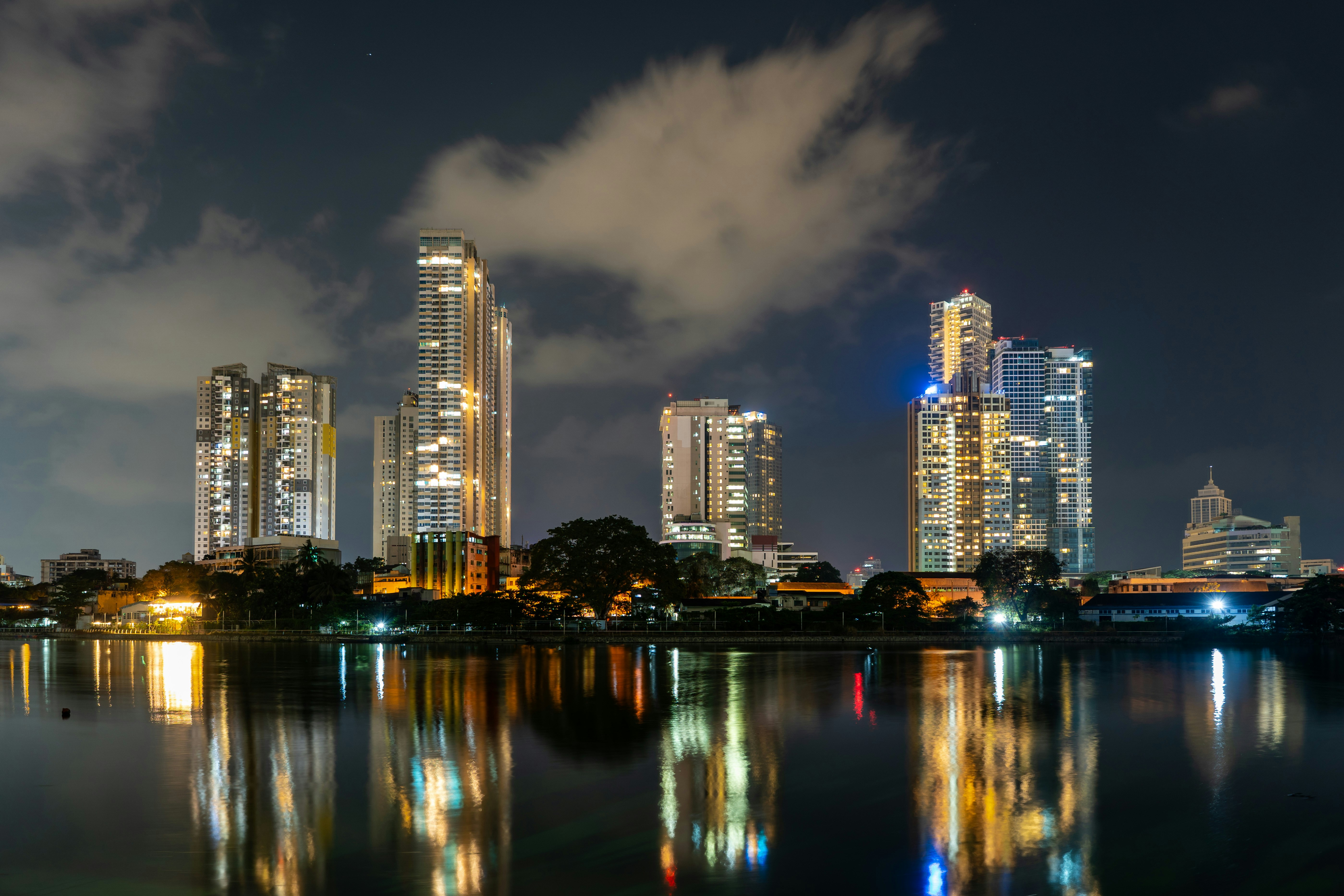 Midnight Skyline Ripples: City Lights Reflected on Calm Waters