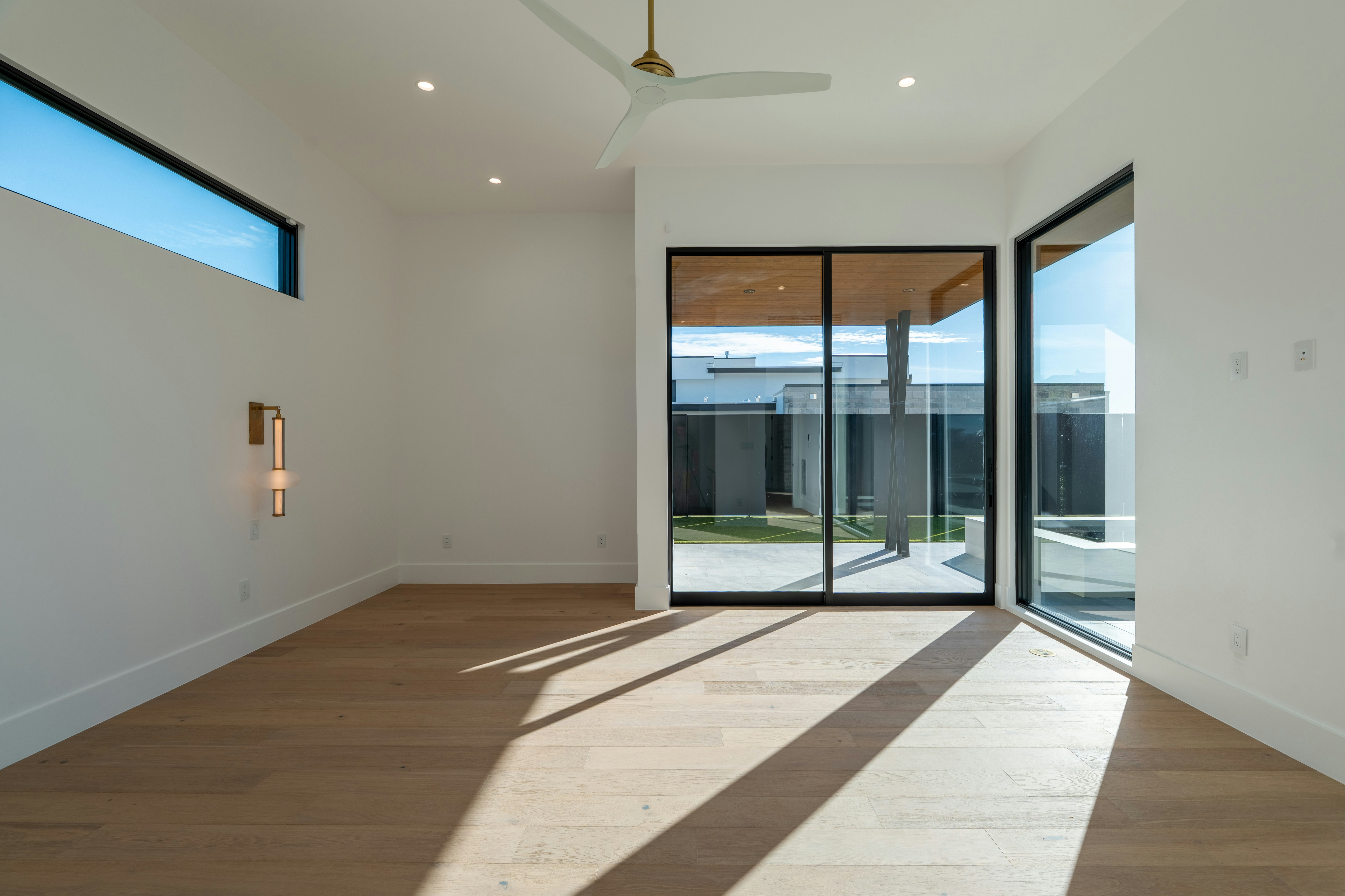 Sunlit Modern Living Room Framed by Glass Doors