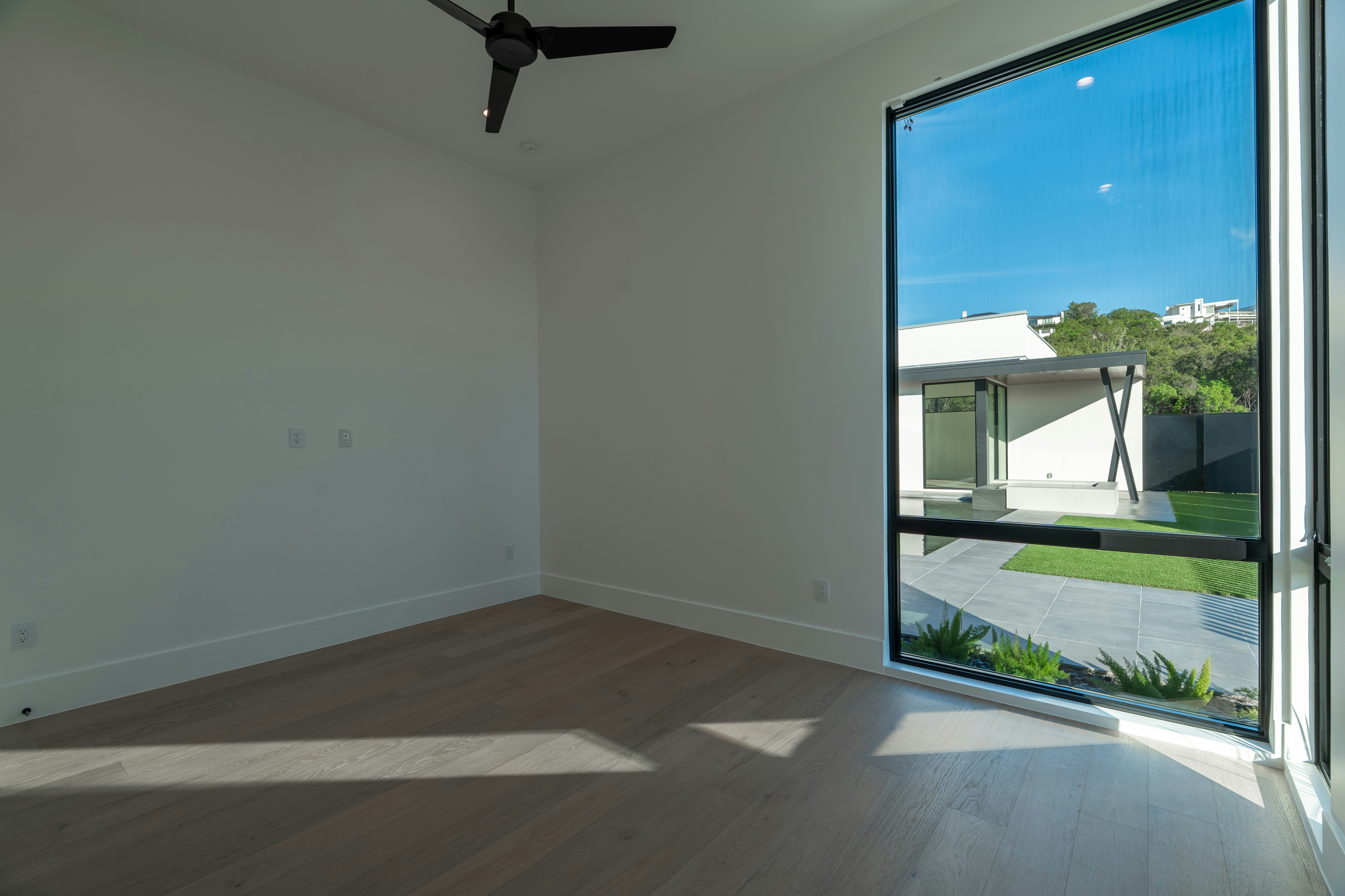 Sunlit Corner: A Modern Empty Room Framed by a Large Window