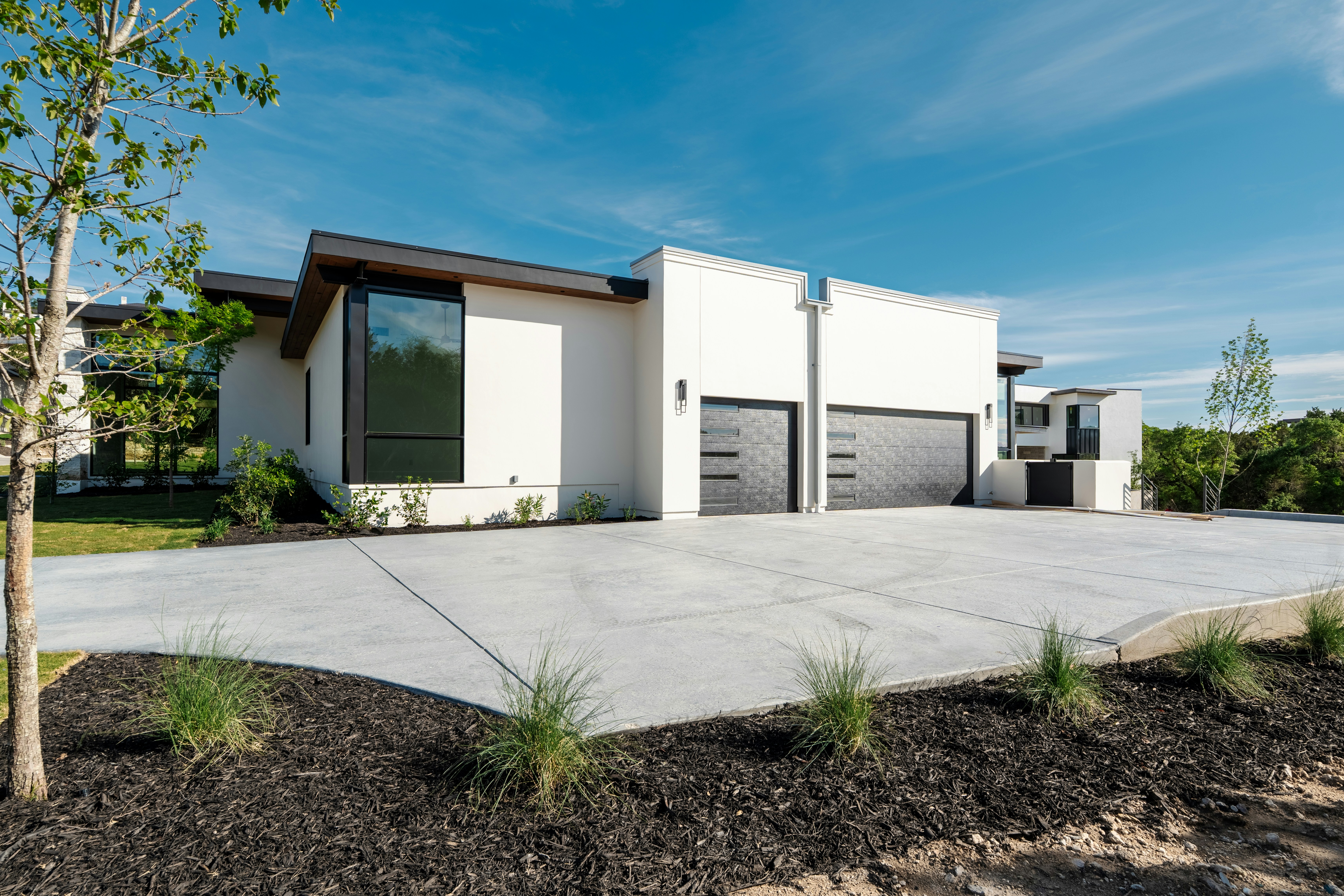 Modern Retreat: Clean Geometry and Sunlit Driveway