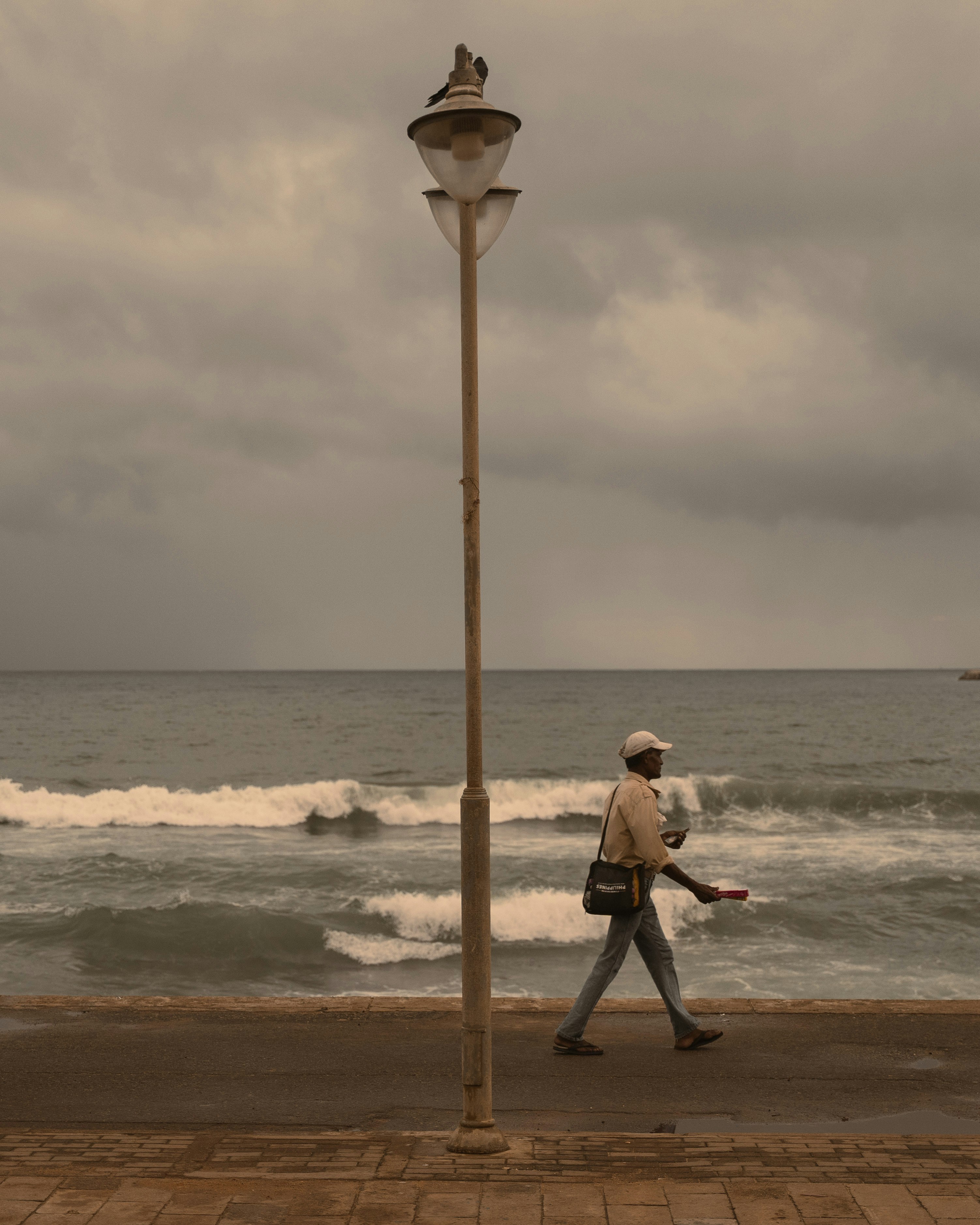 Coastal Stroll Under a Distant Lantern
