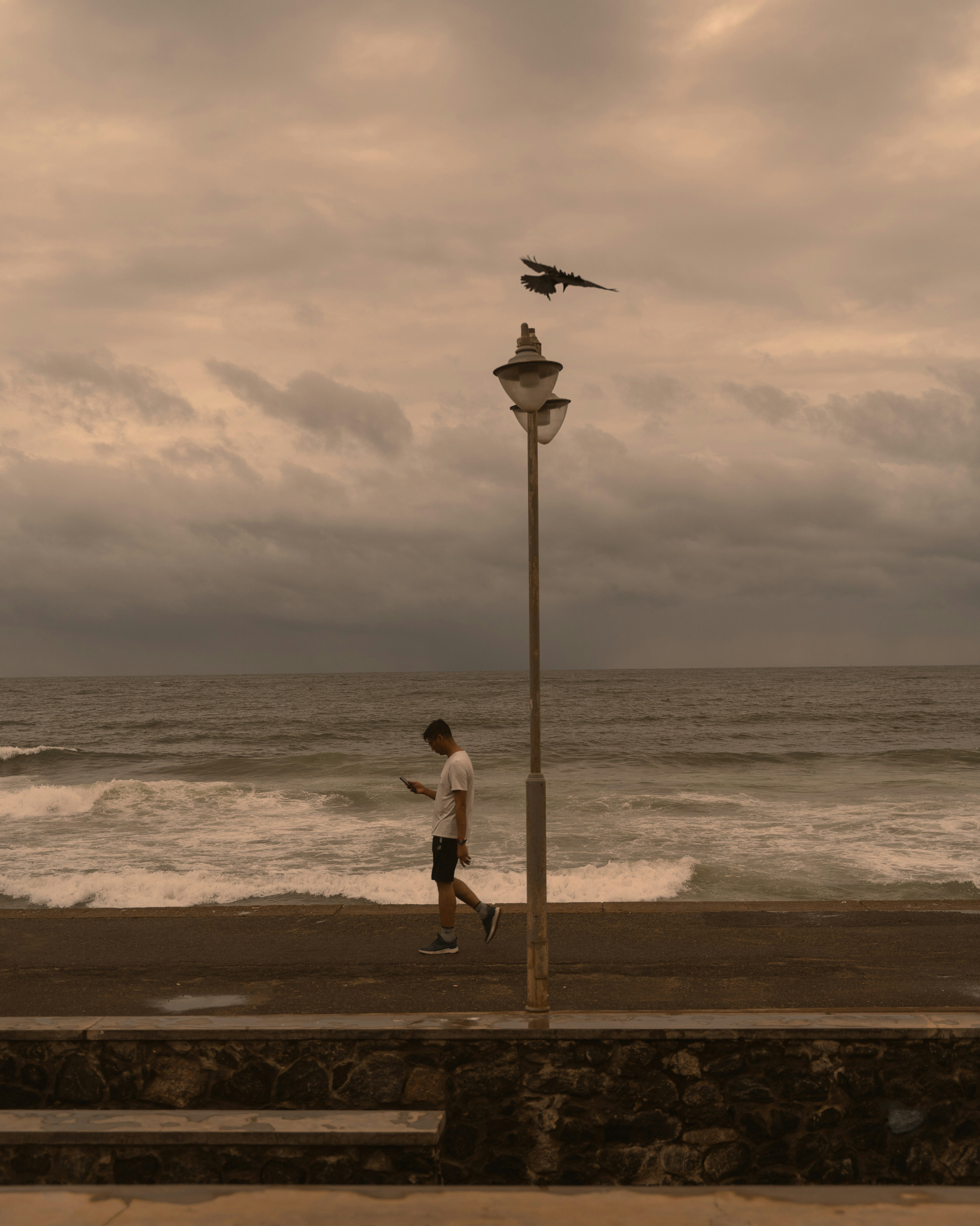 Standby at Dusk: A Solitary Jogger Beneath a Monitoring Streetlamp