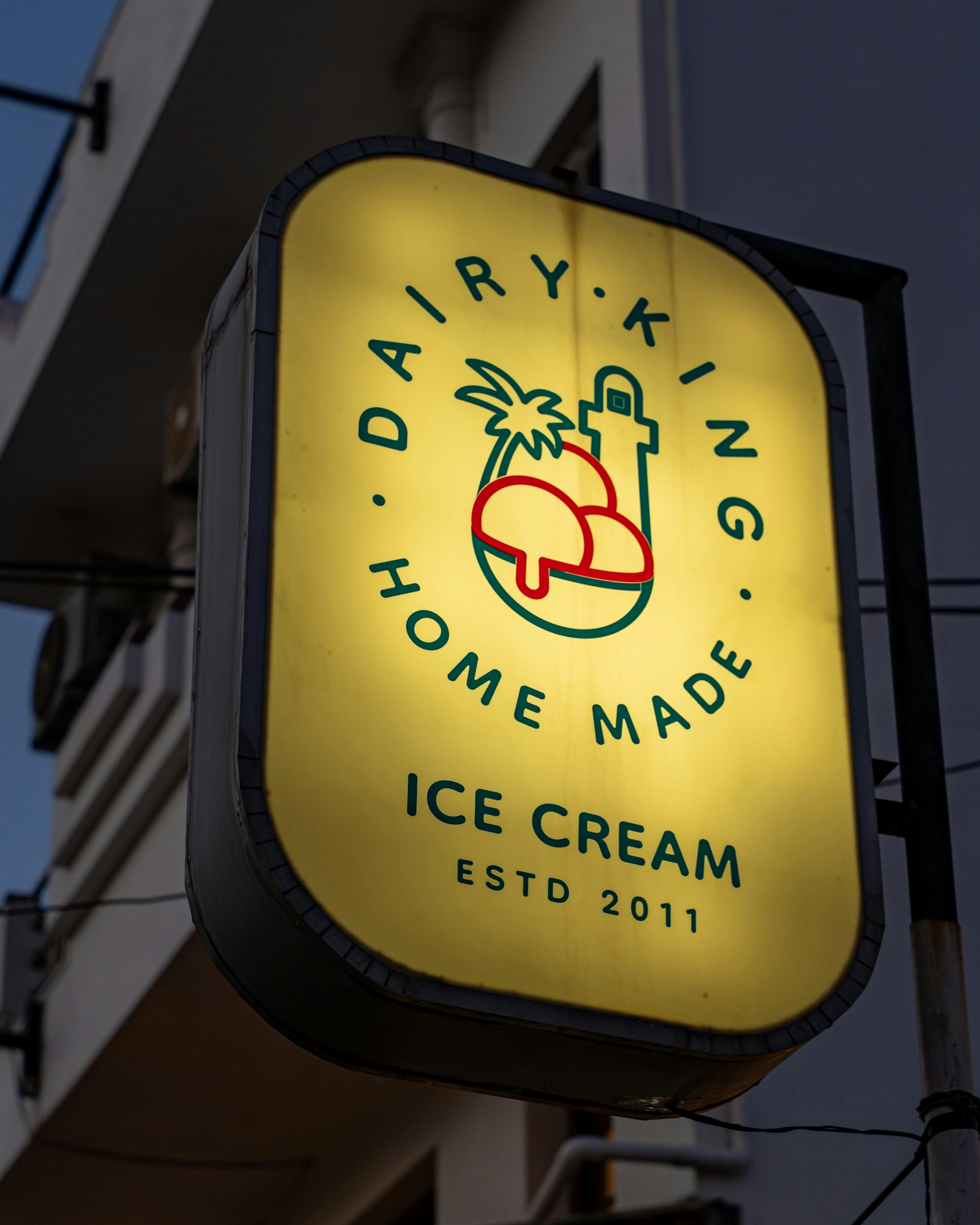 A glowing sign for dairy king home made ice cream.
