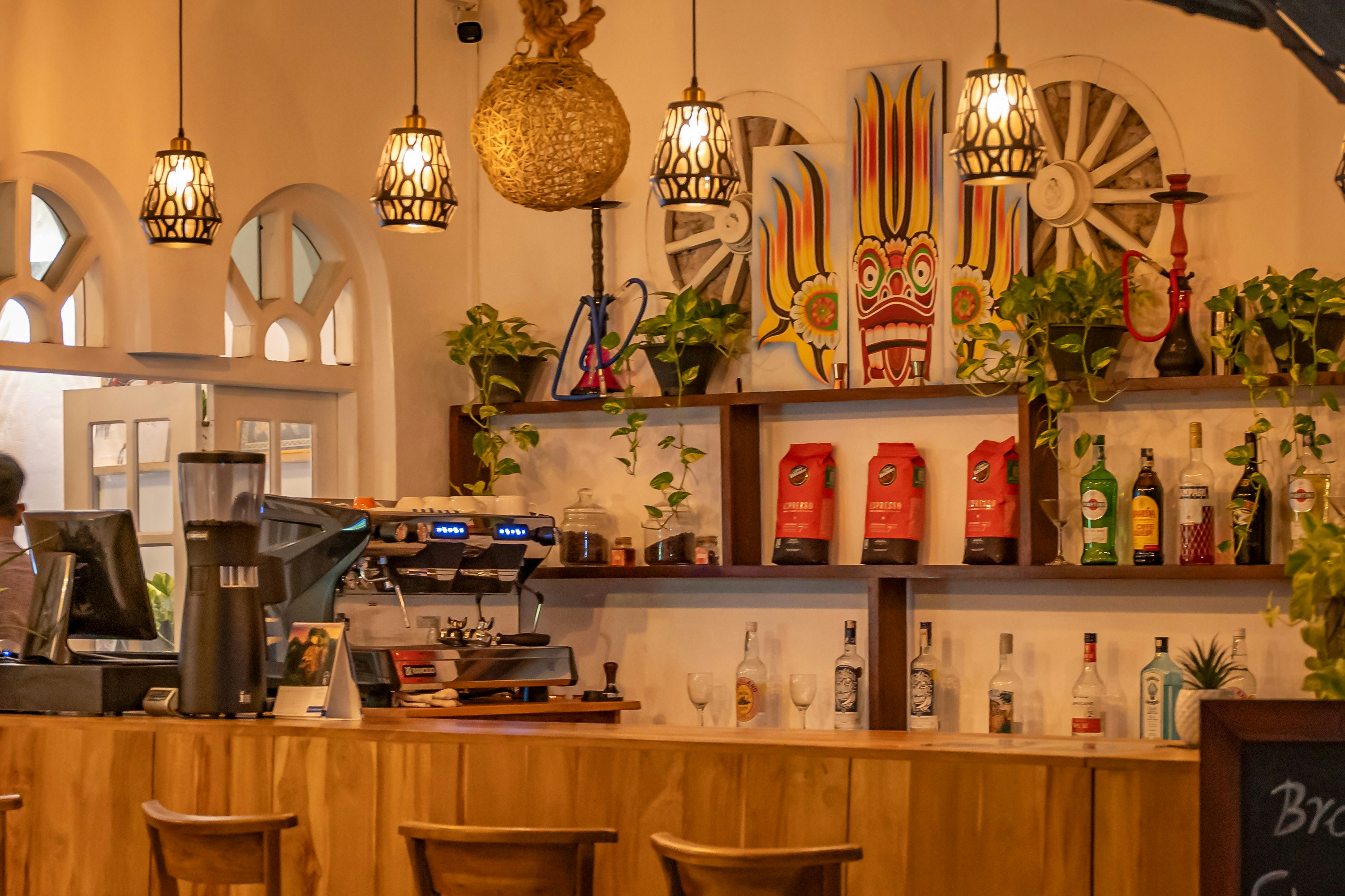 Colorful Bar Brewscape with Artistic Masks Above the Shelf