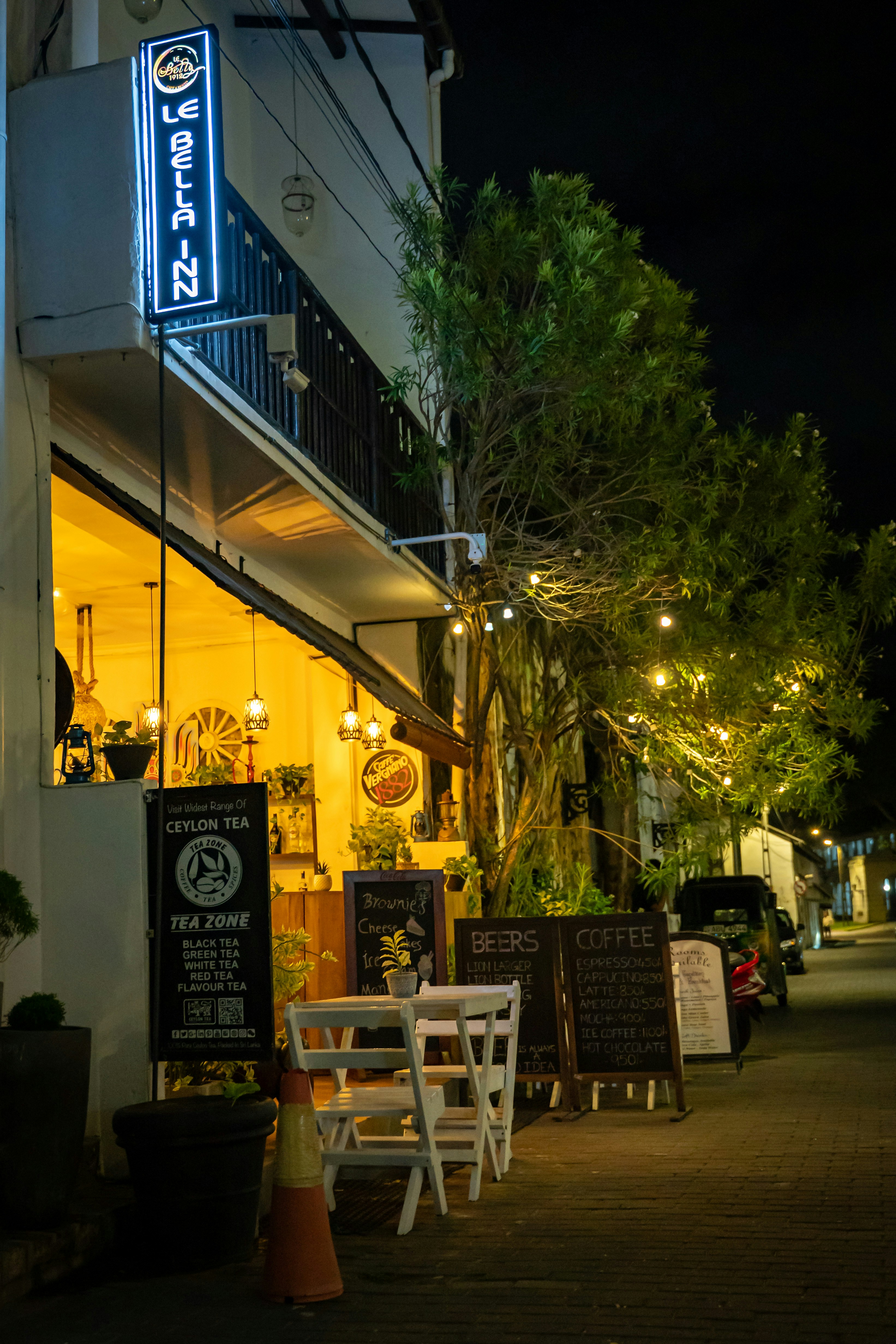 Night in the Lantern Lane: Neon Sign Above a Café Alley
