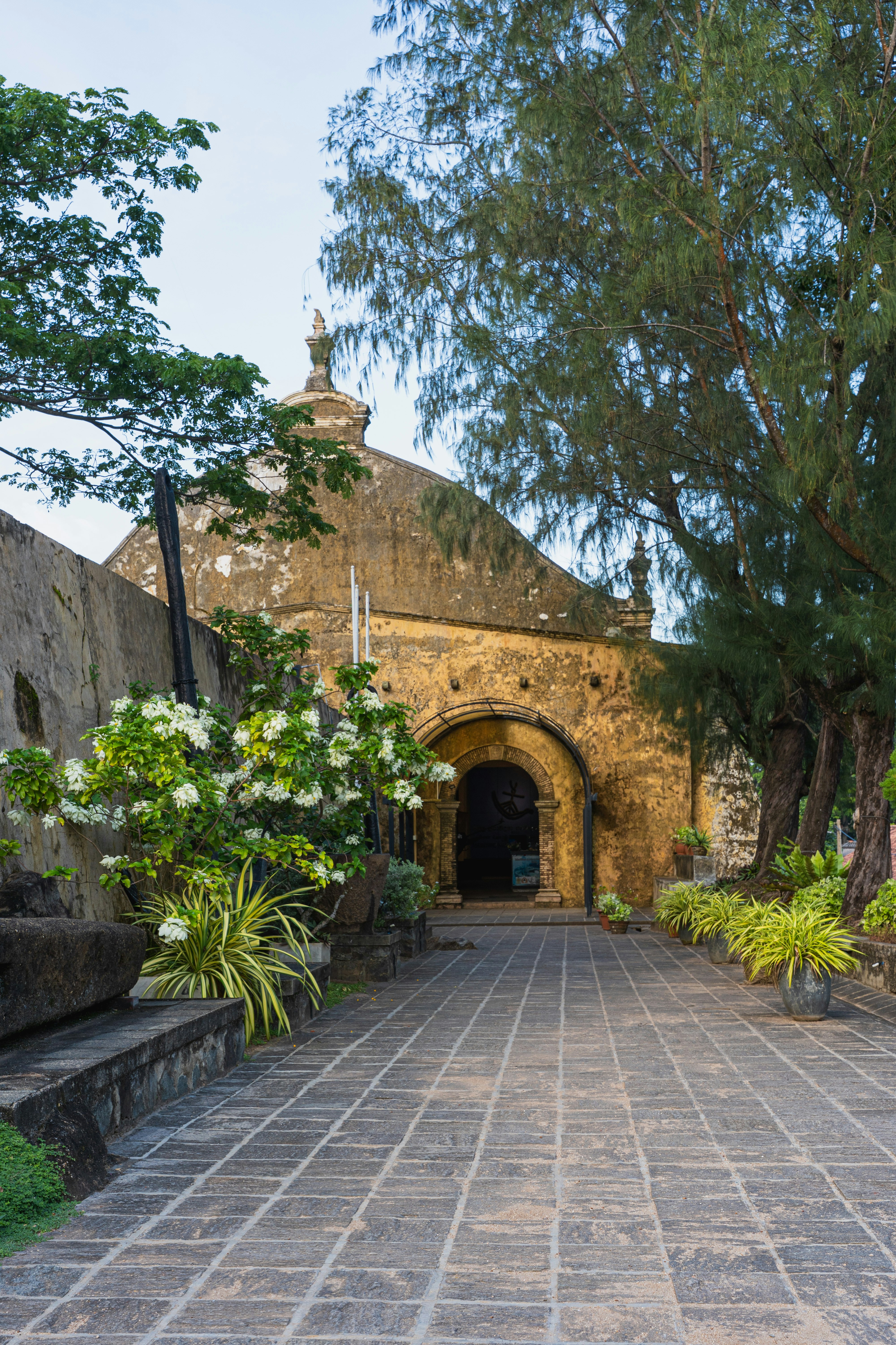 Gateway of Golden Walls: A Quiet Courtyard to the Arched Entrance